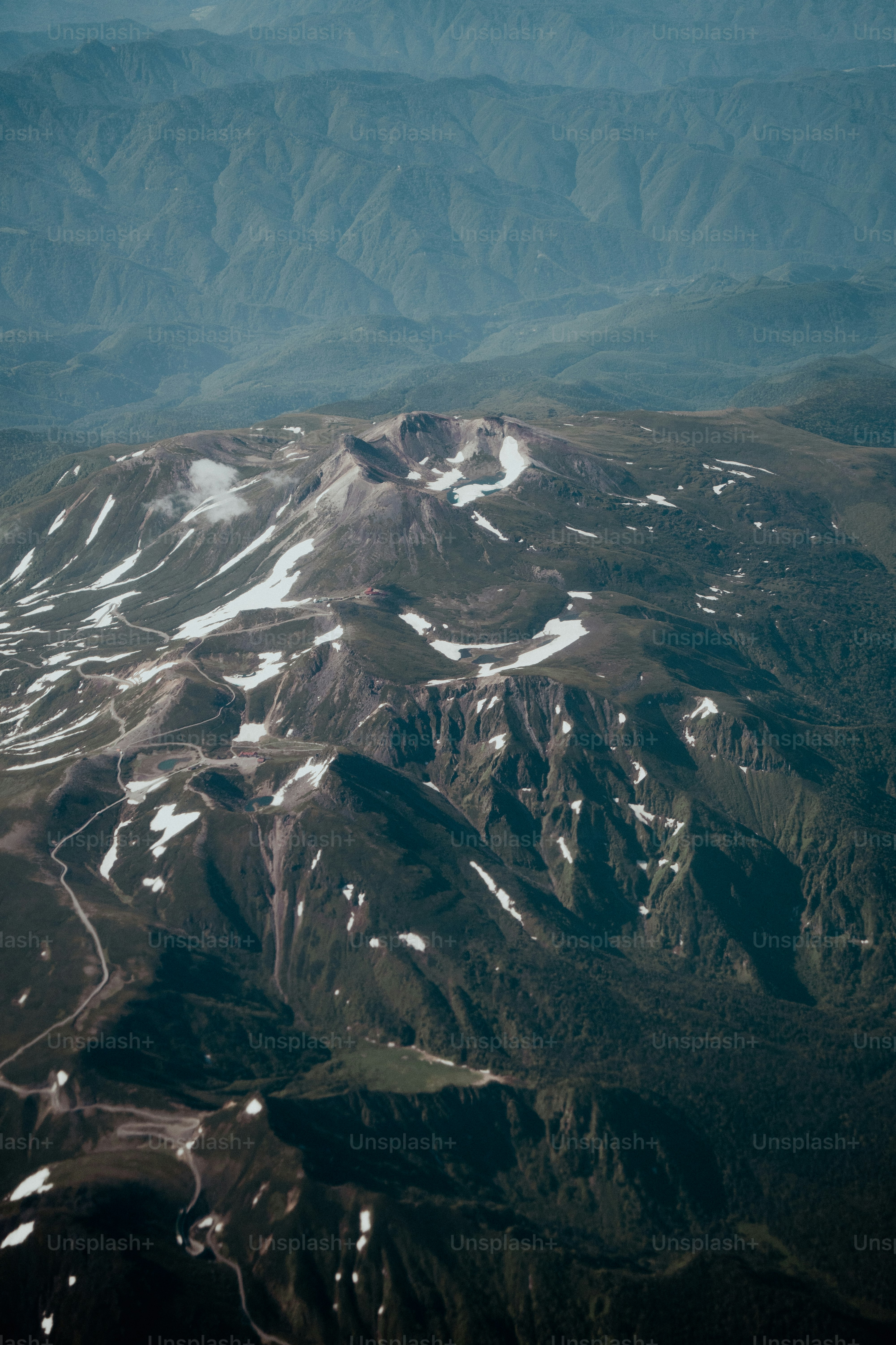 An aerial view of a snow covered mountain range photo – Japan Image on ...