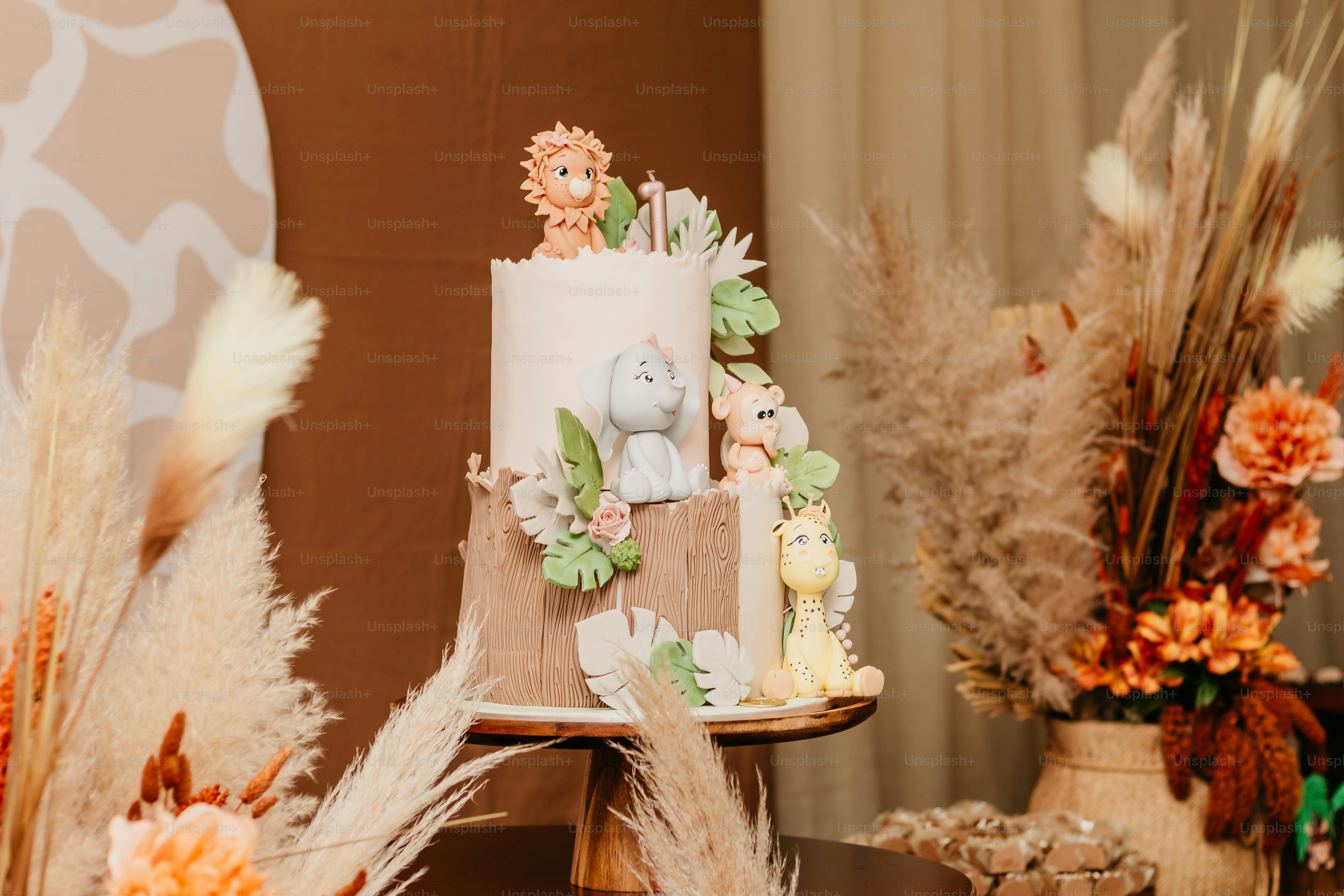 A three tiered cake decorated with flowers and animals photo – Image on ...