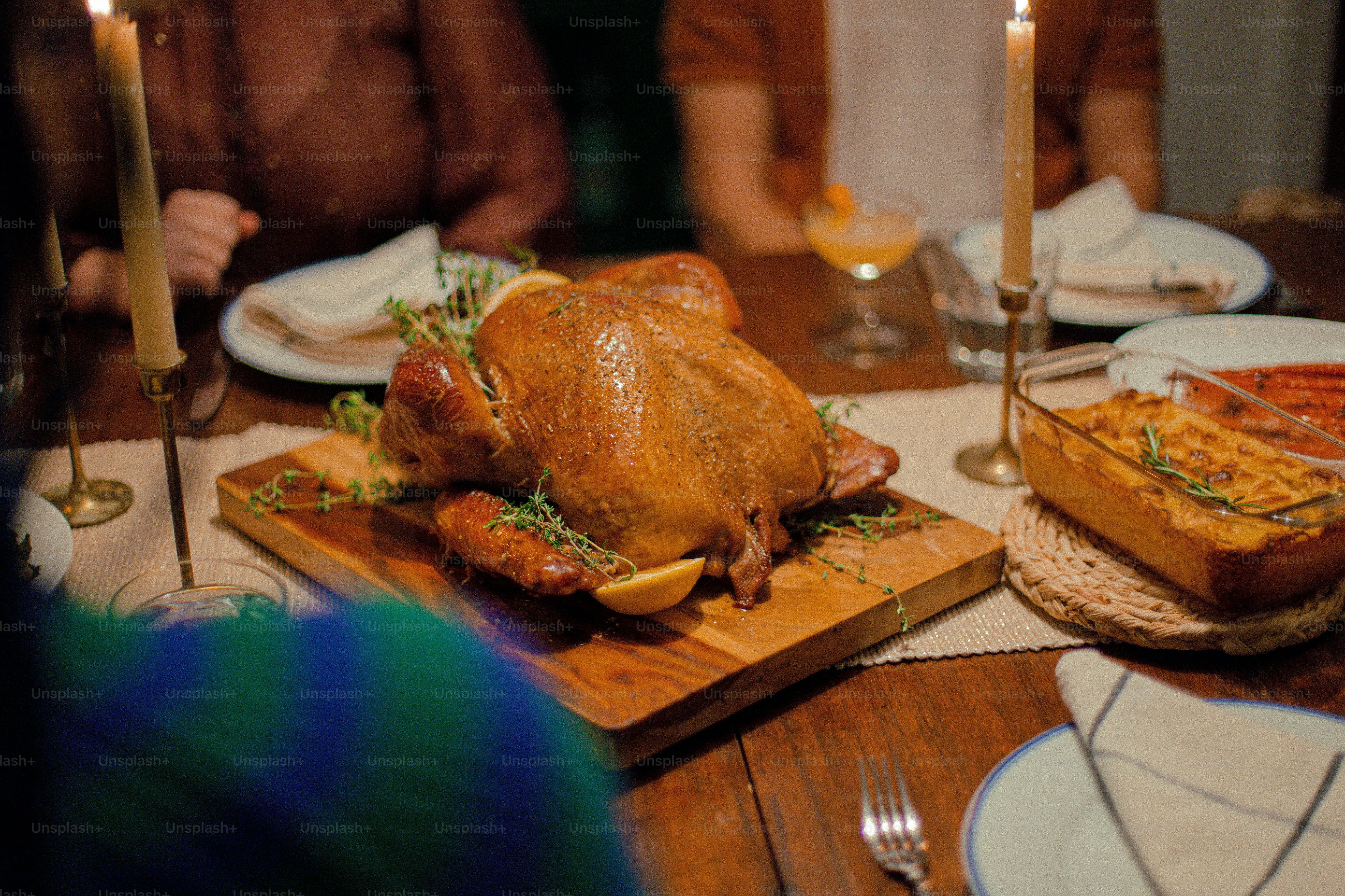 A turkey sitting on a cutting board on a table photo – Laden table ...