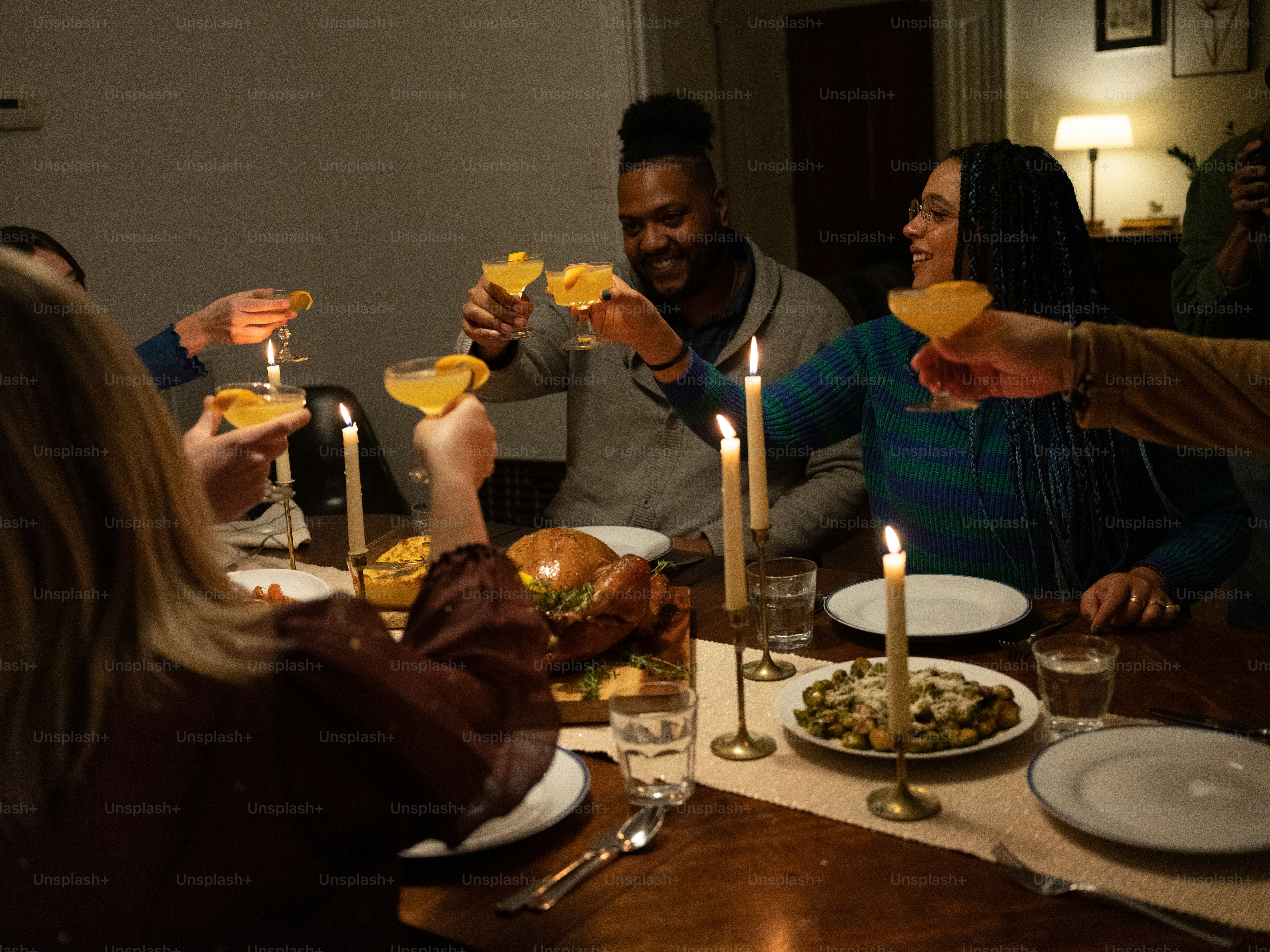 A group of people sitting around a dinner table photo – Dining room ...