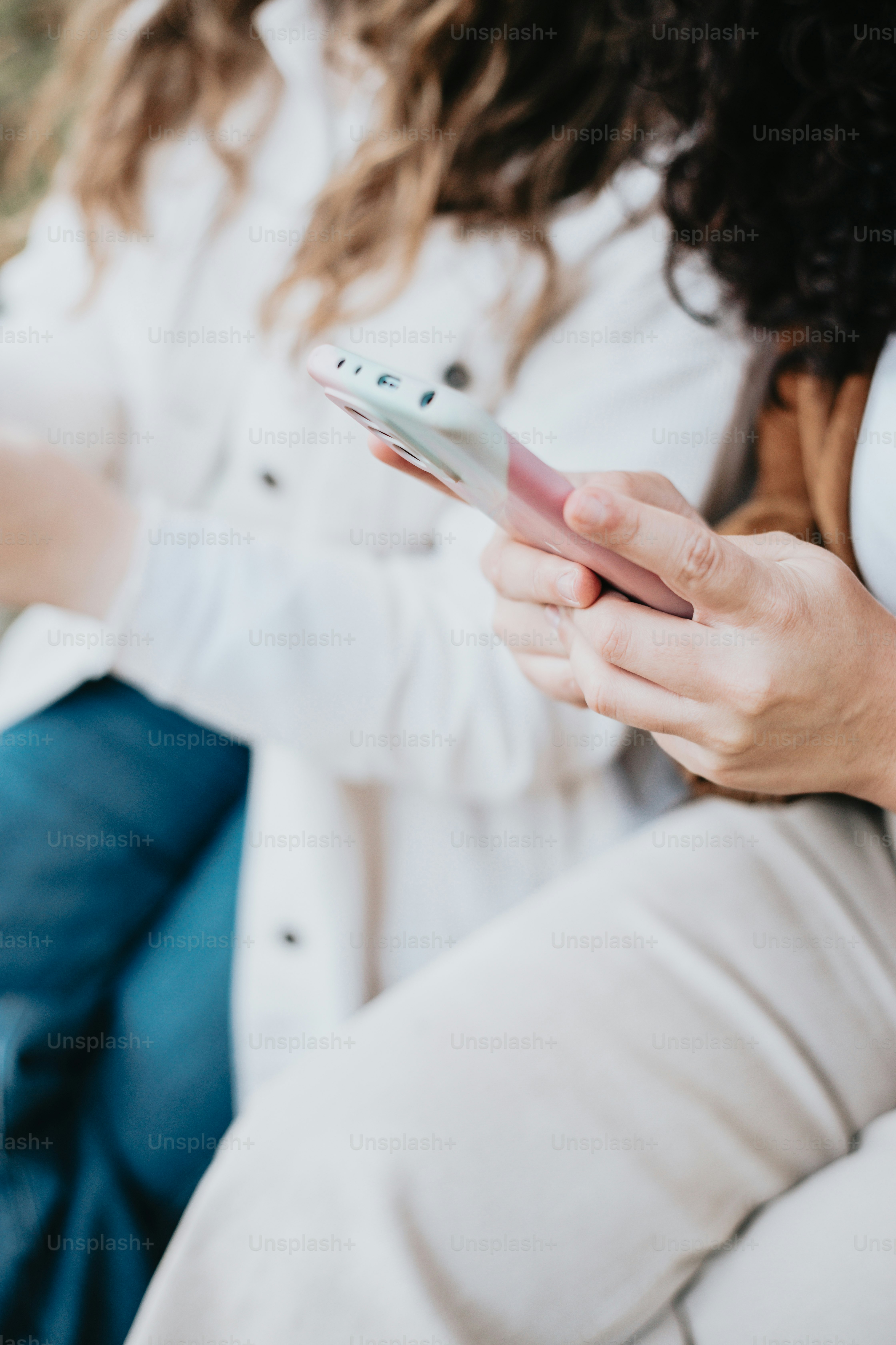 A close up of a person holding a cell phone photo – People Image on ...