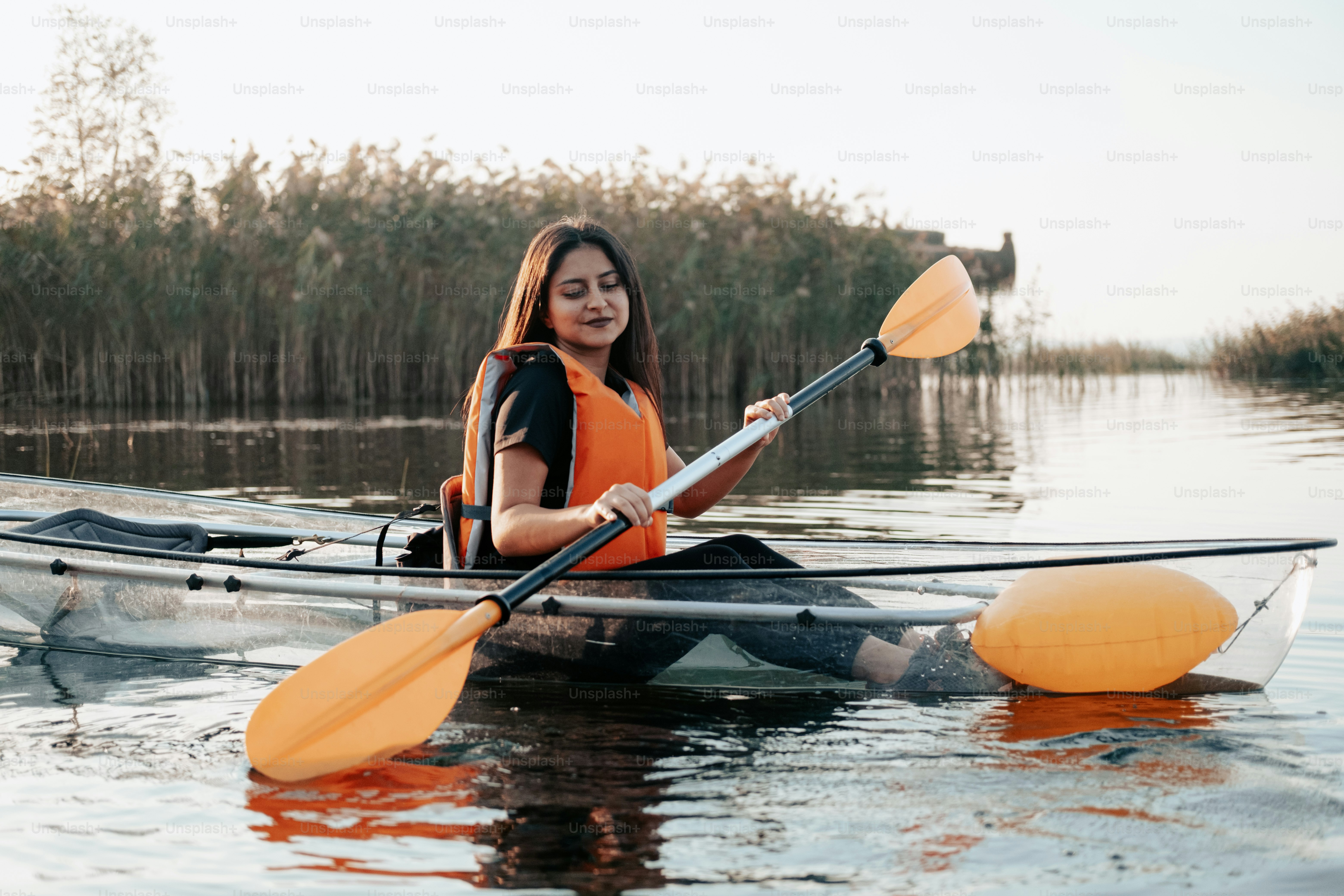 A man in a canoe paddling on the water photo – Kayaking Image on Unsplash