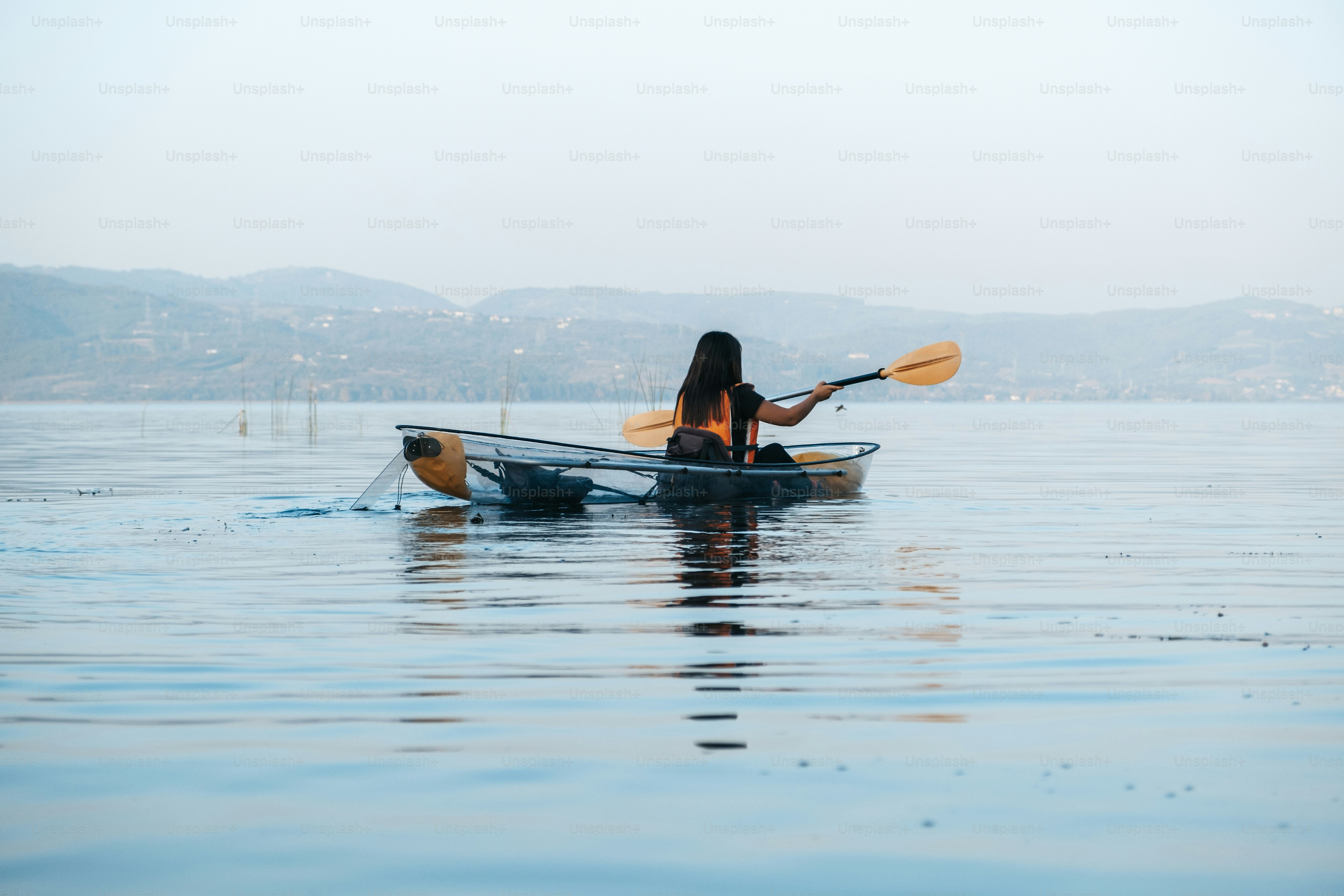 A woman in a kayak paddling on the water photo – Sport Image on Unsplash