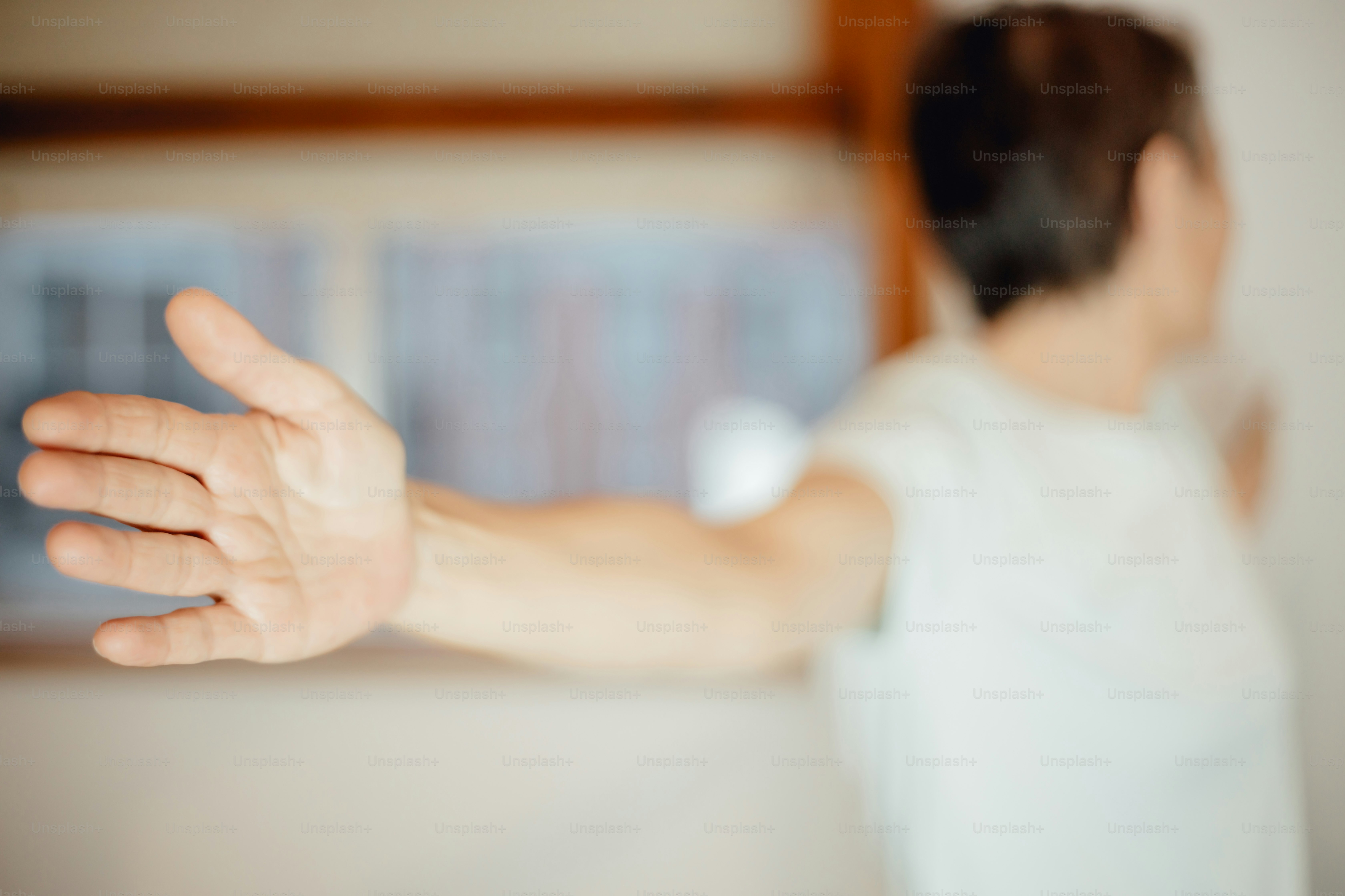 A person with their arm outstretched in front of a mirror photo ...