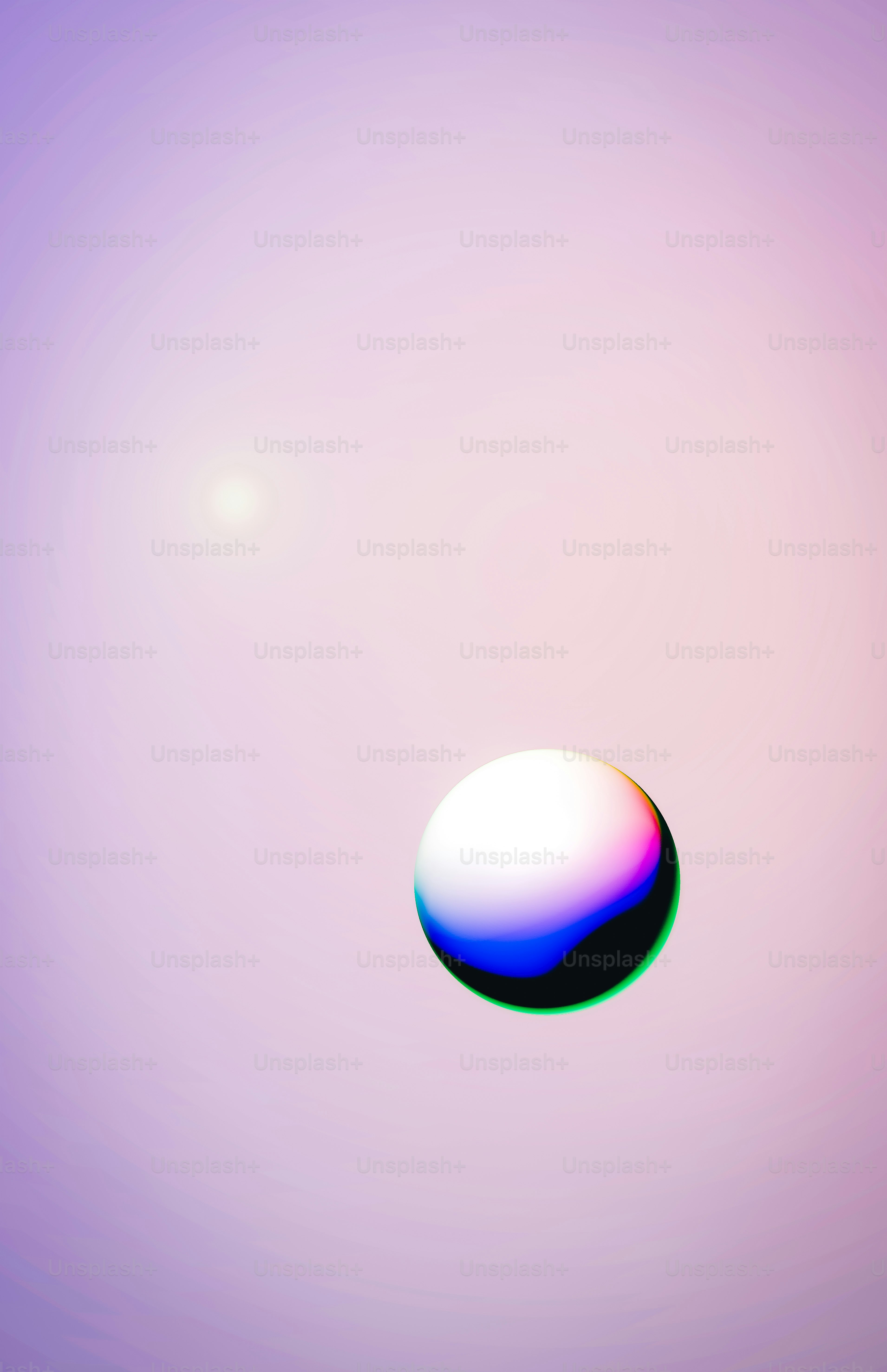 A pink and blue object sitting on top of a white surface photo ...