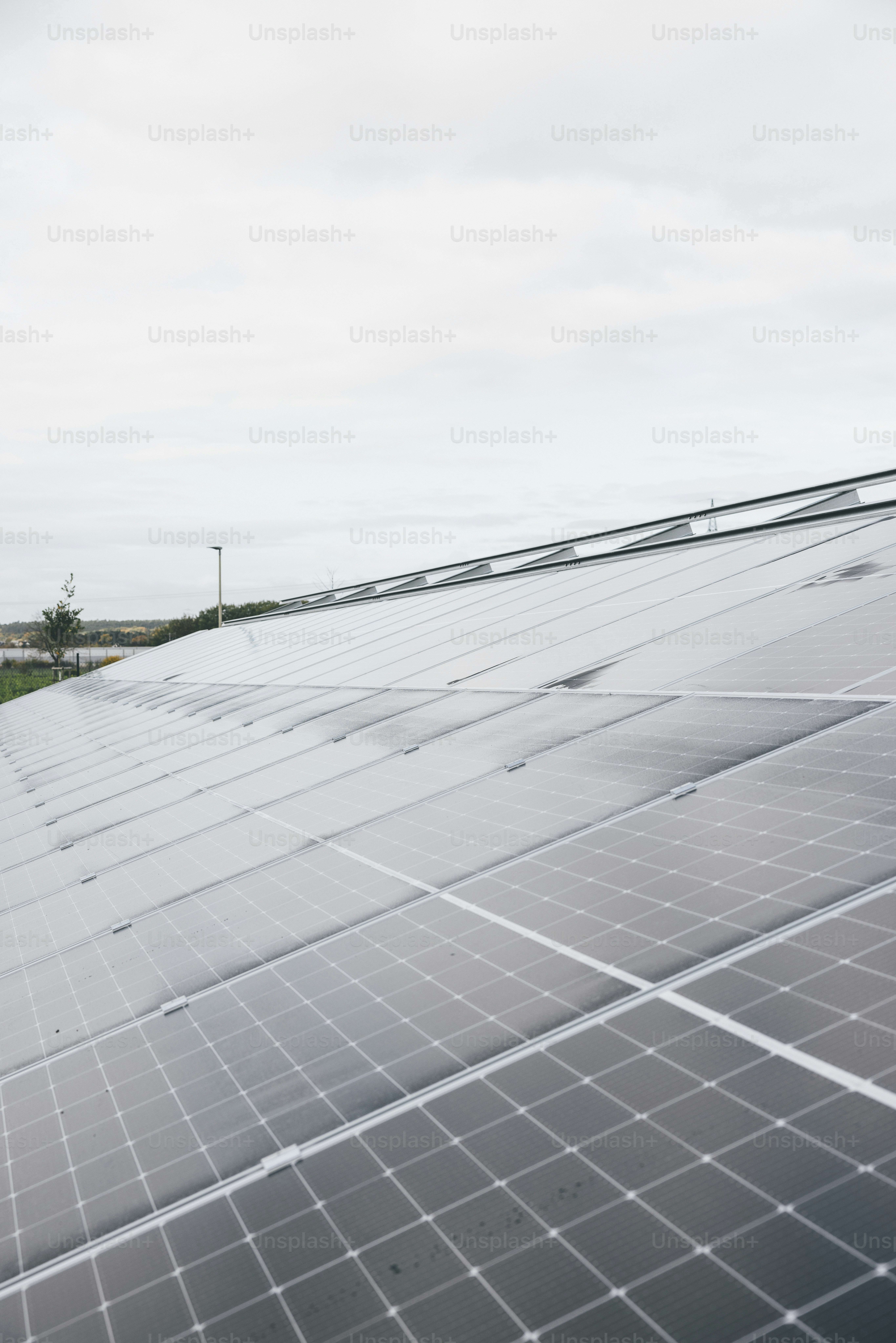 A row of solar panels sitting on top of a roof photo – City Image on ...