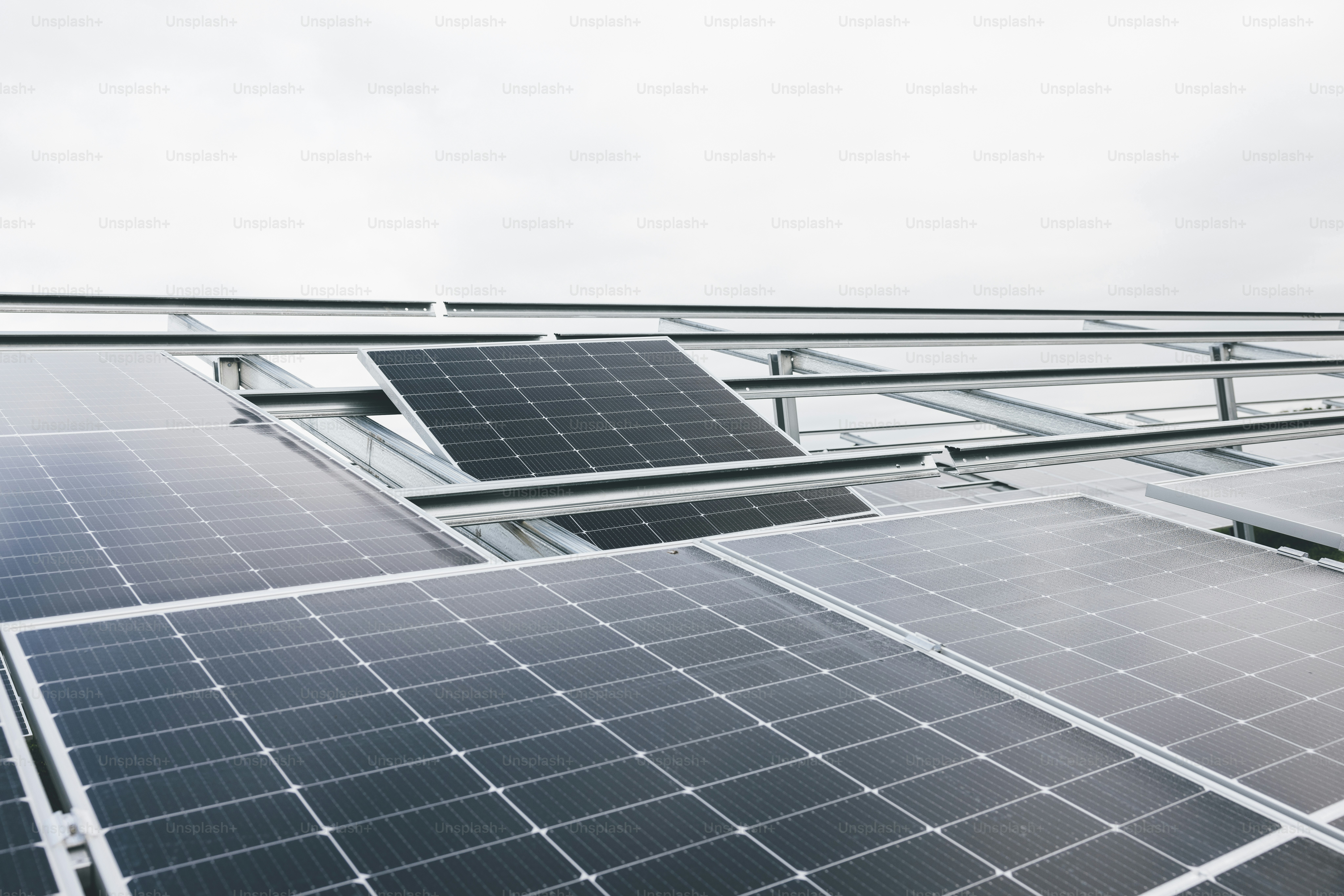 A row of solar panels on top of a building photo – Background Image on ...