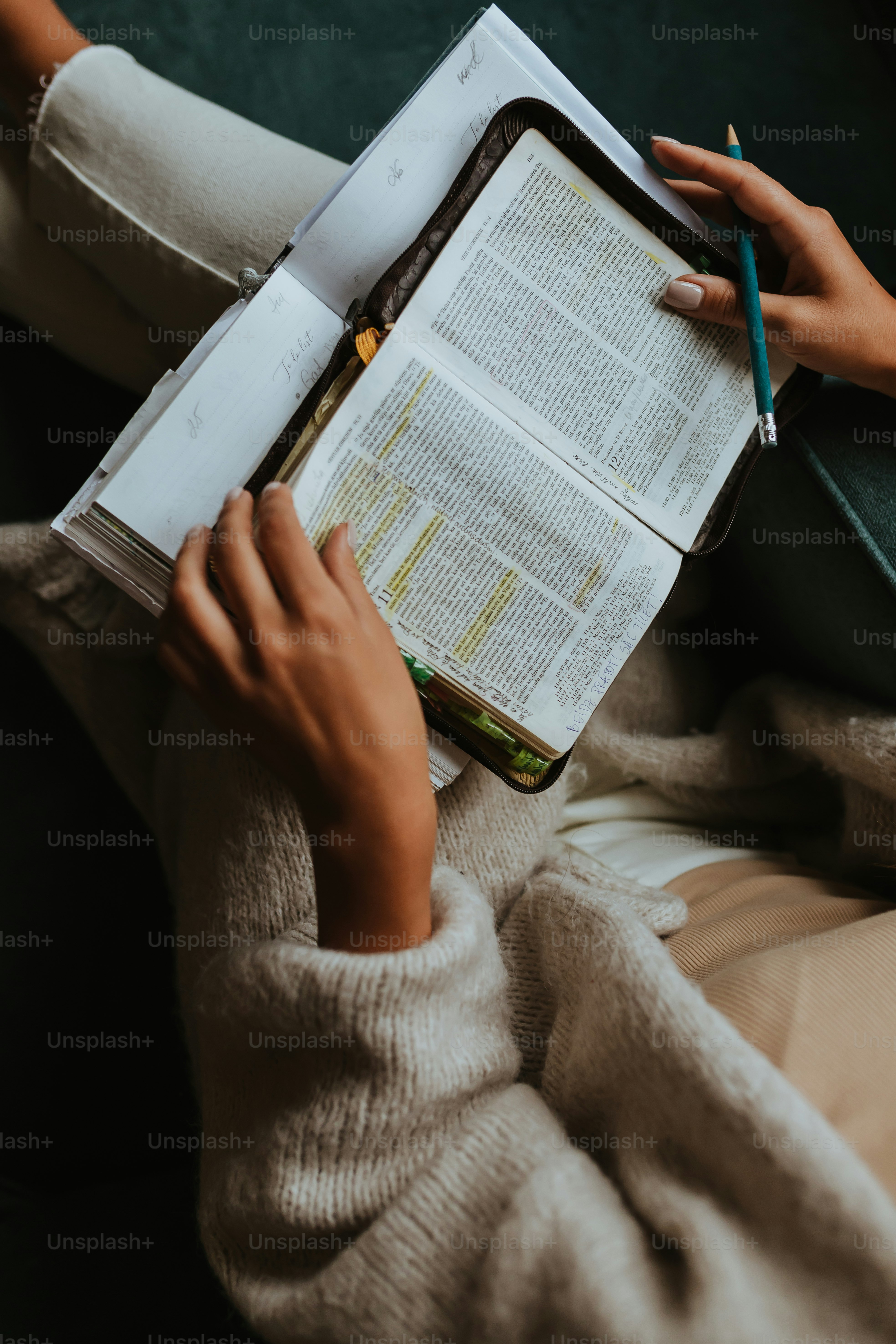 A person writing on a book photo – Holy writ Image on Unsplash