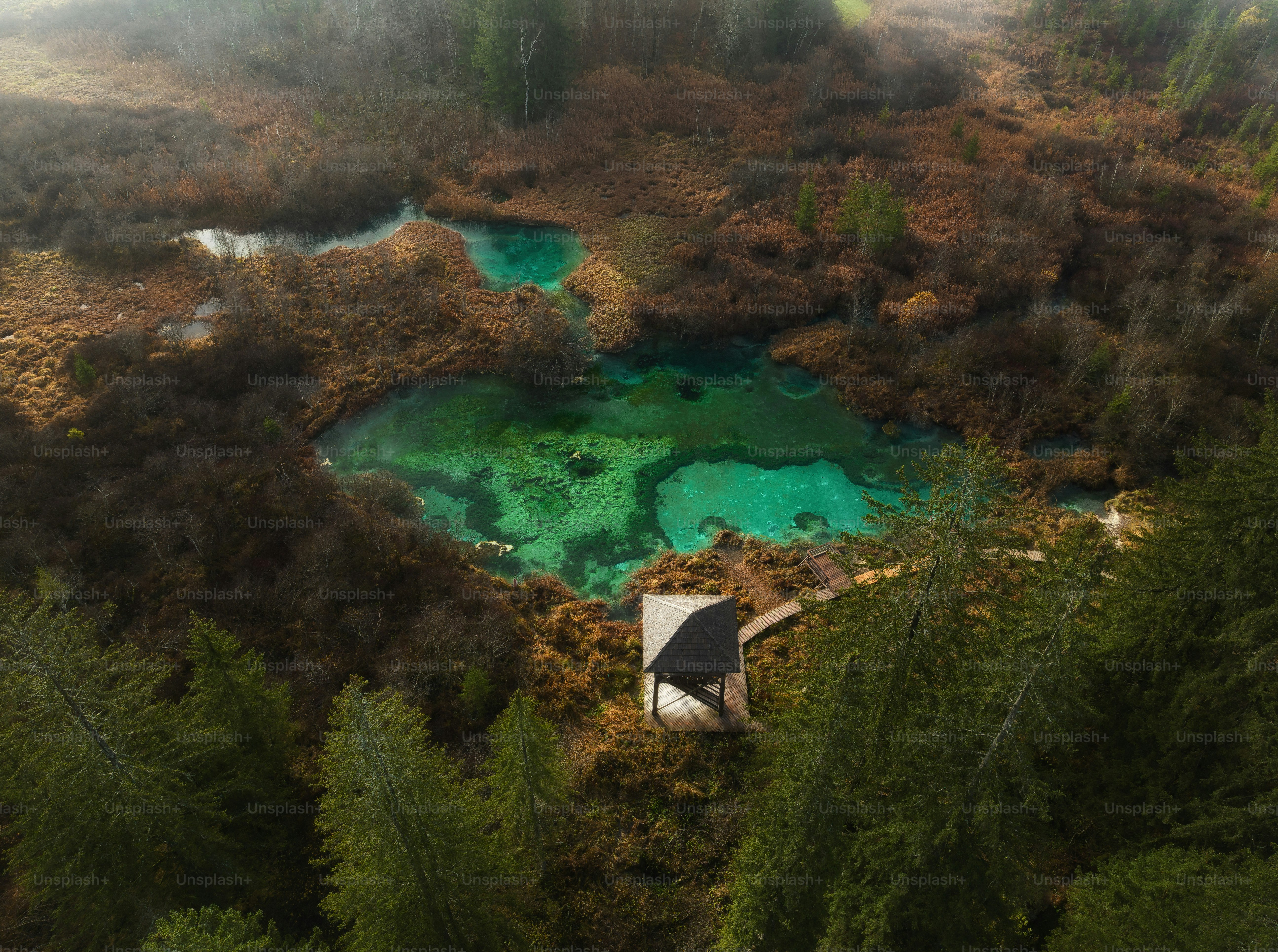 An aerial view of a body of water surrounded by land photo – Lake Image ...