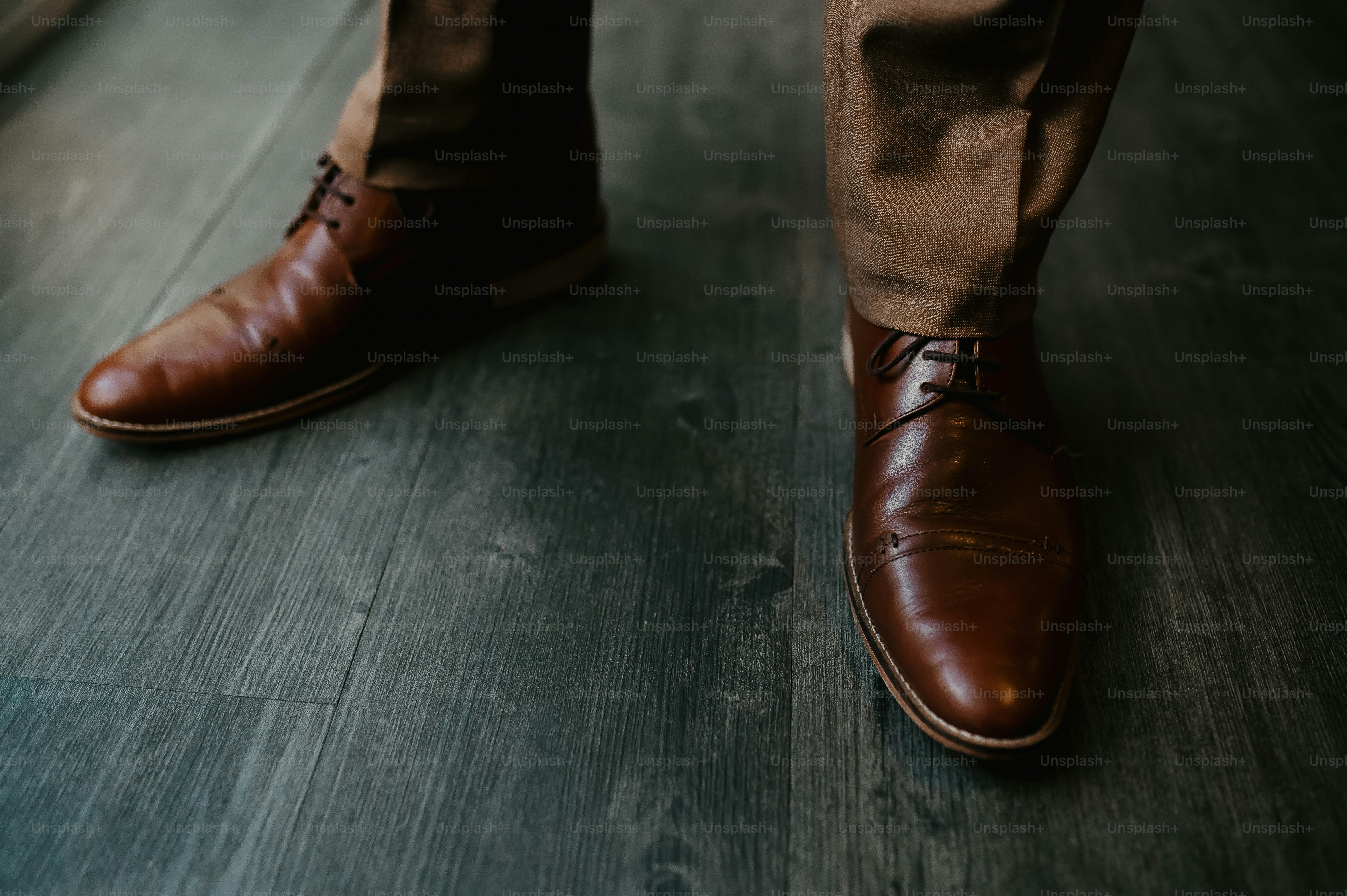 A close up of a person wearing brown shoes photo – Shoes fashion Image ...
