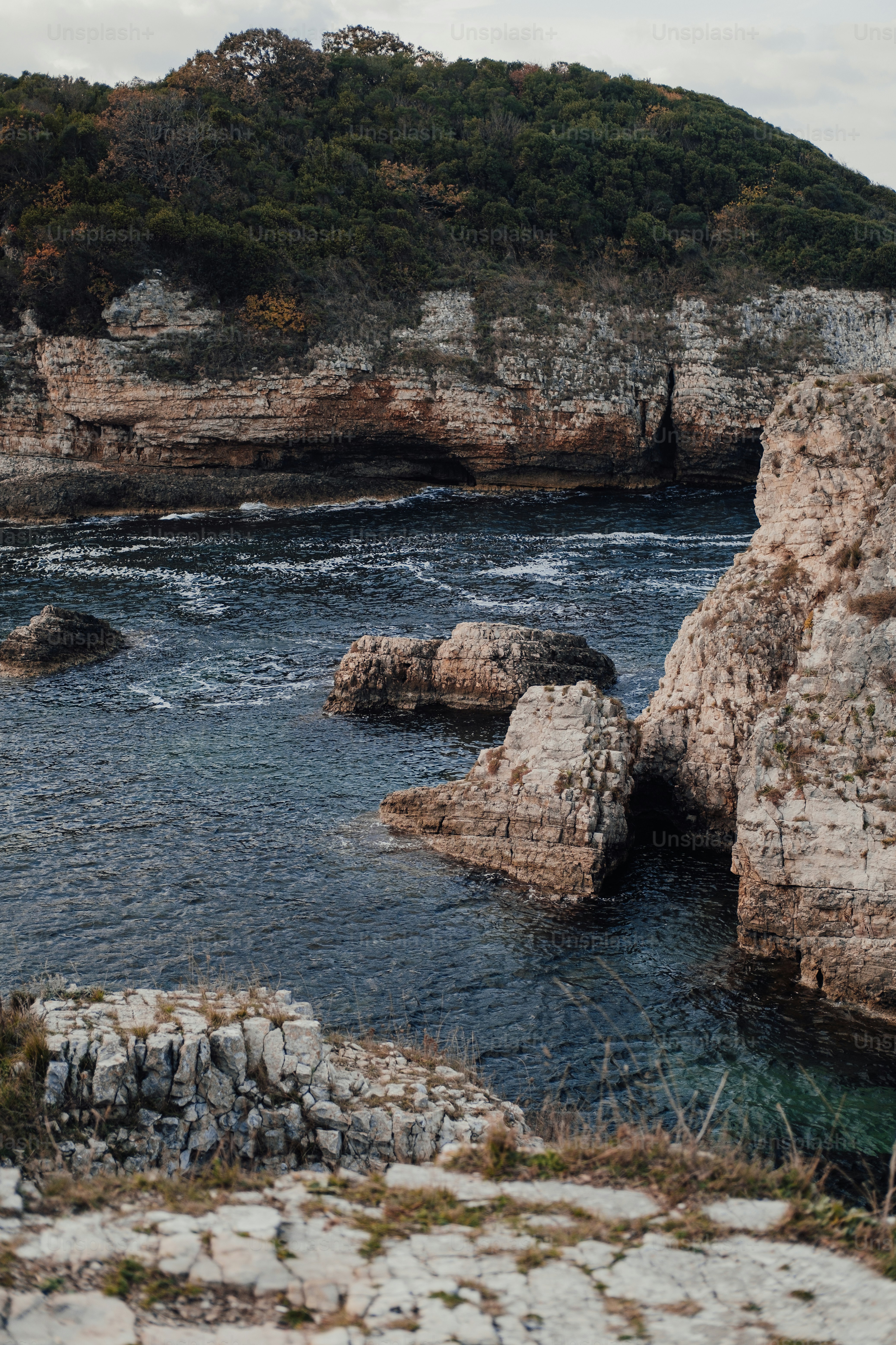 A large body of water surrounded by rocks photo – Nature Image on Unsplash