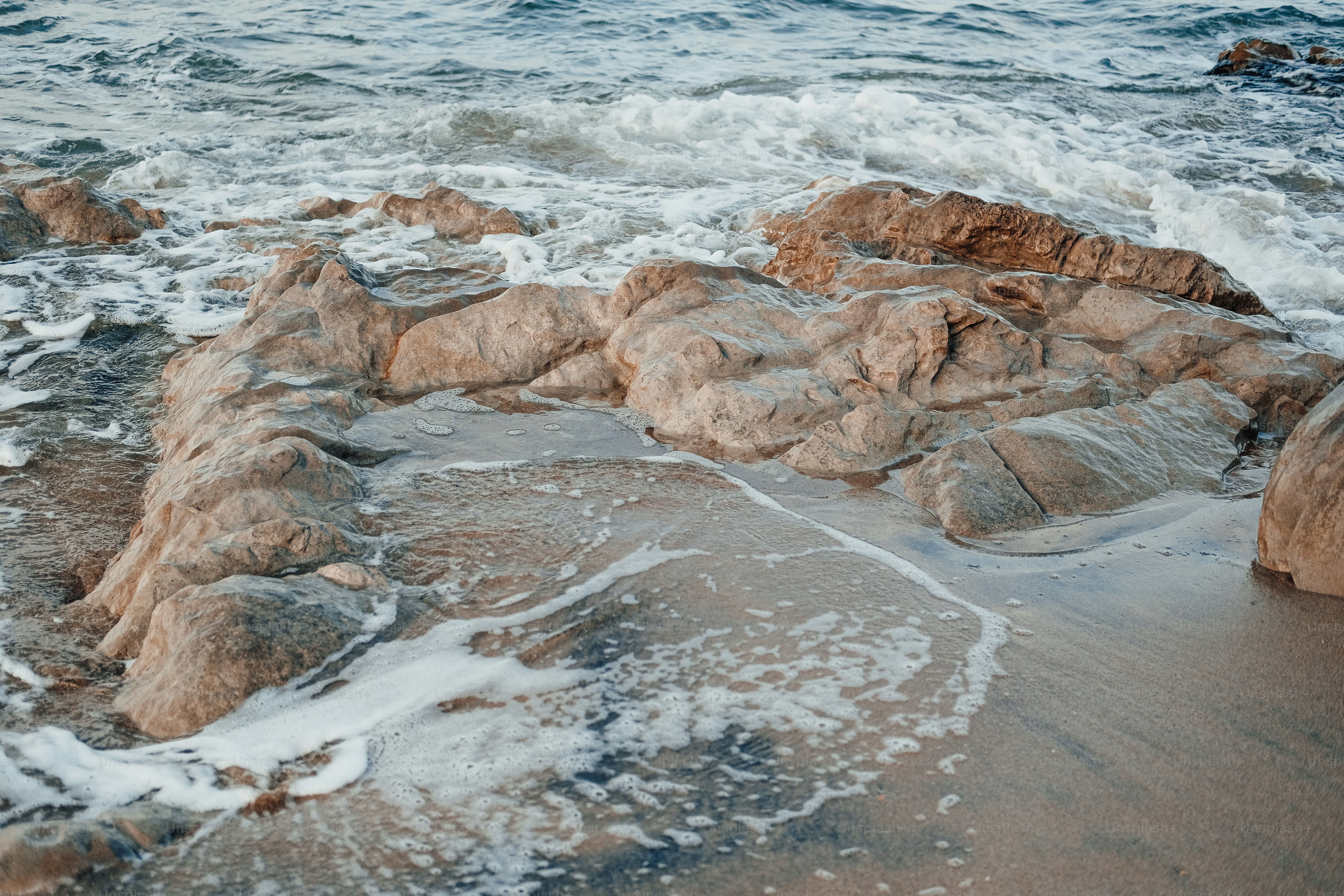 Foto Una playa rocosa con olas rompiendo en las rocas – Costero Imagen ...