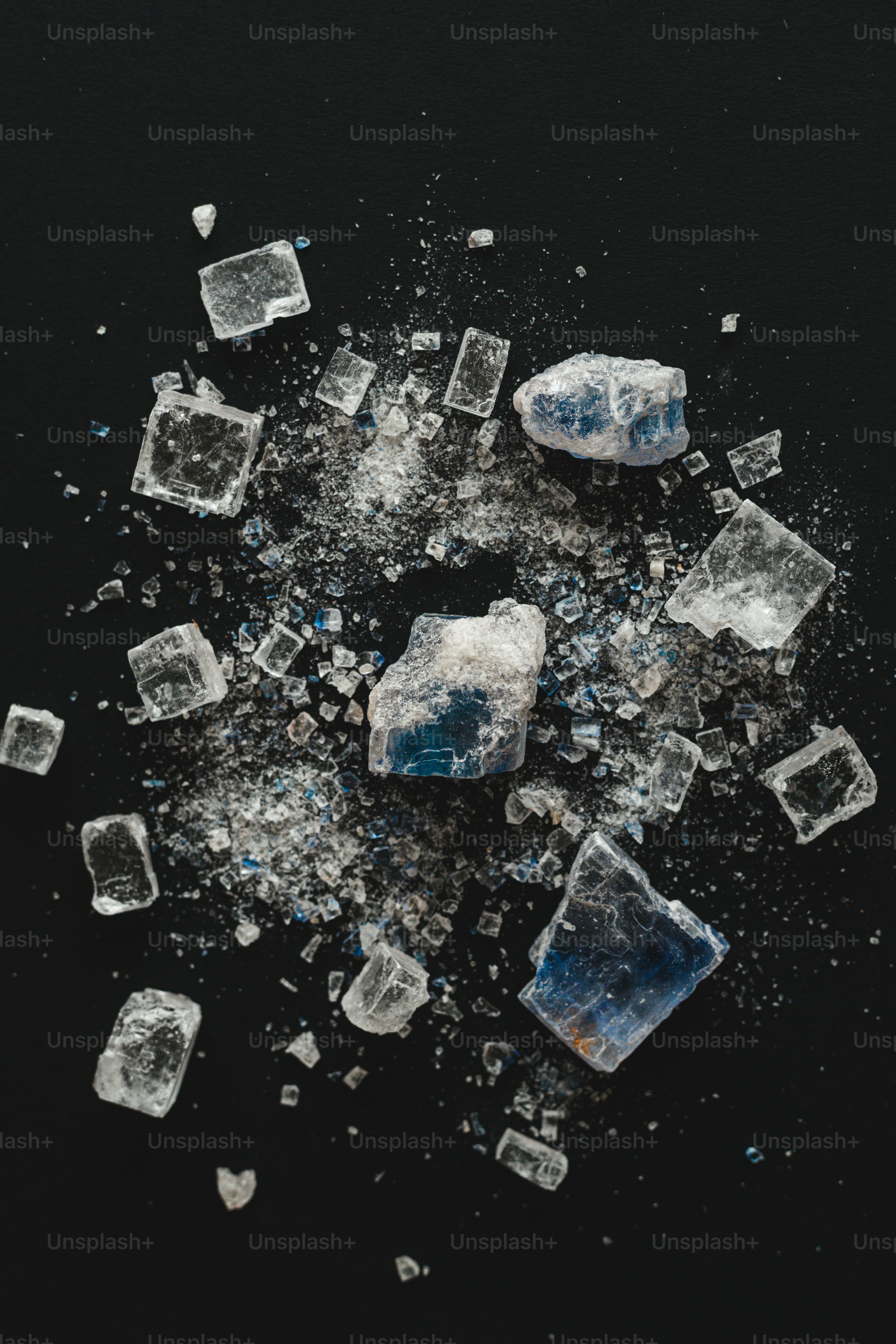 A pile of ice cubes sitting on top of a table photo – Sea salt Image on ...