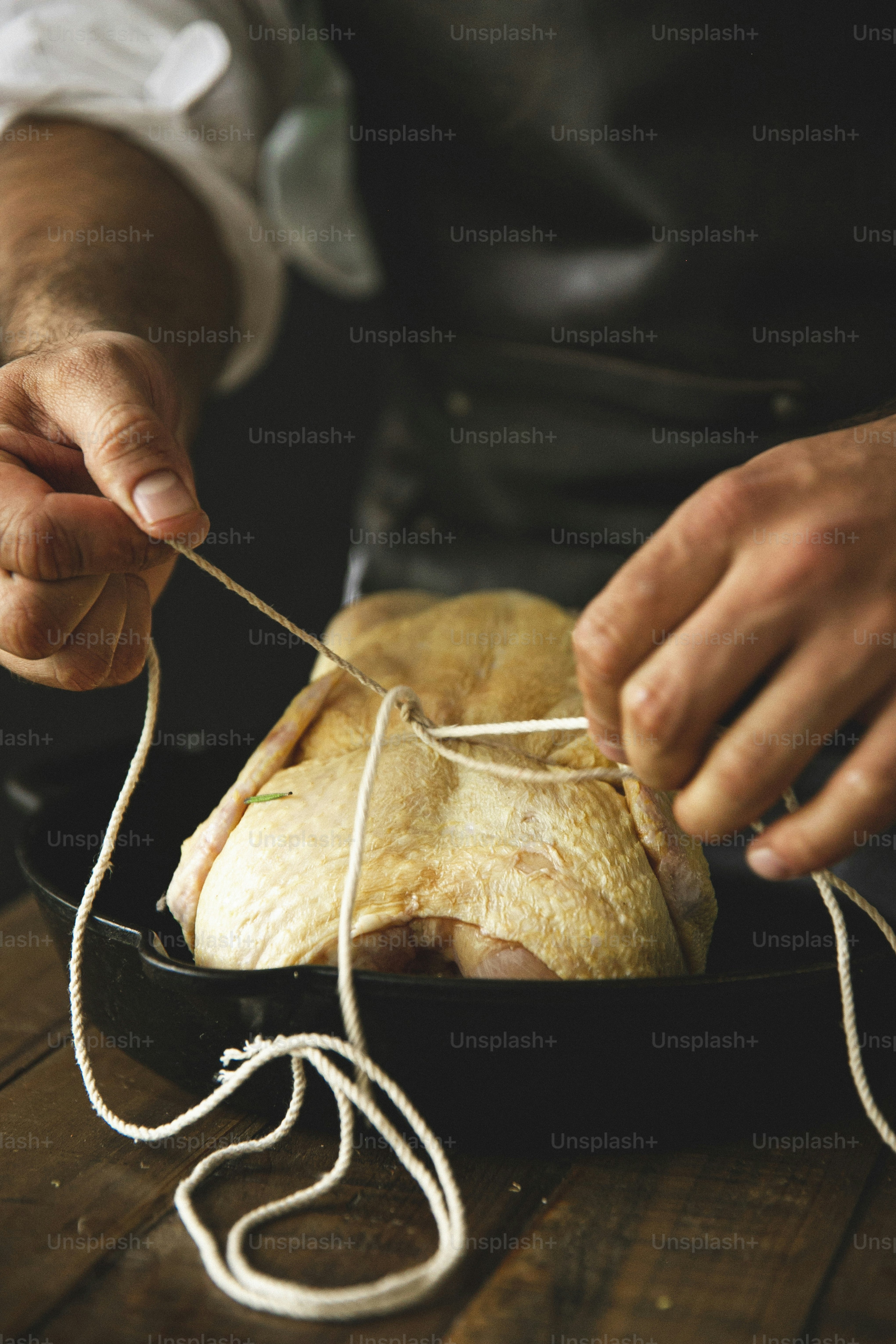 A person pulling a piece of bread from a skillet photo – Chicken meat ...