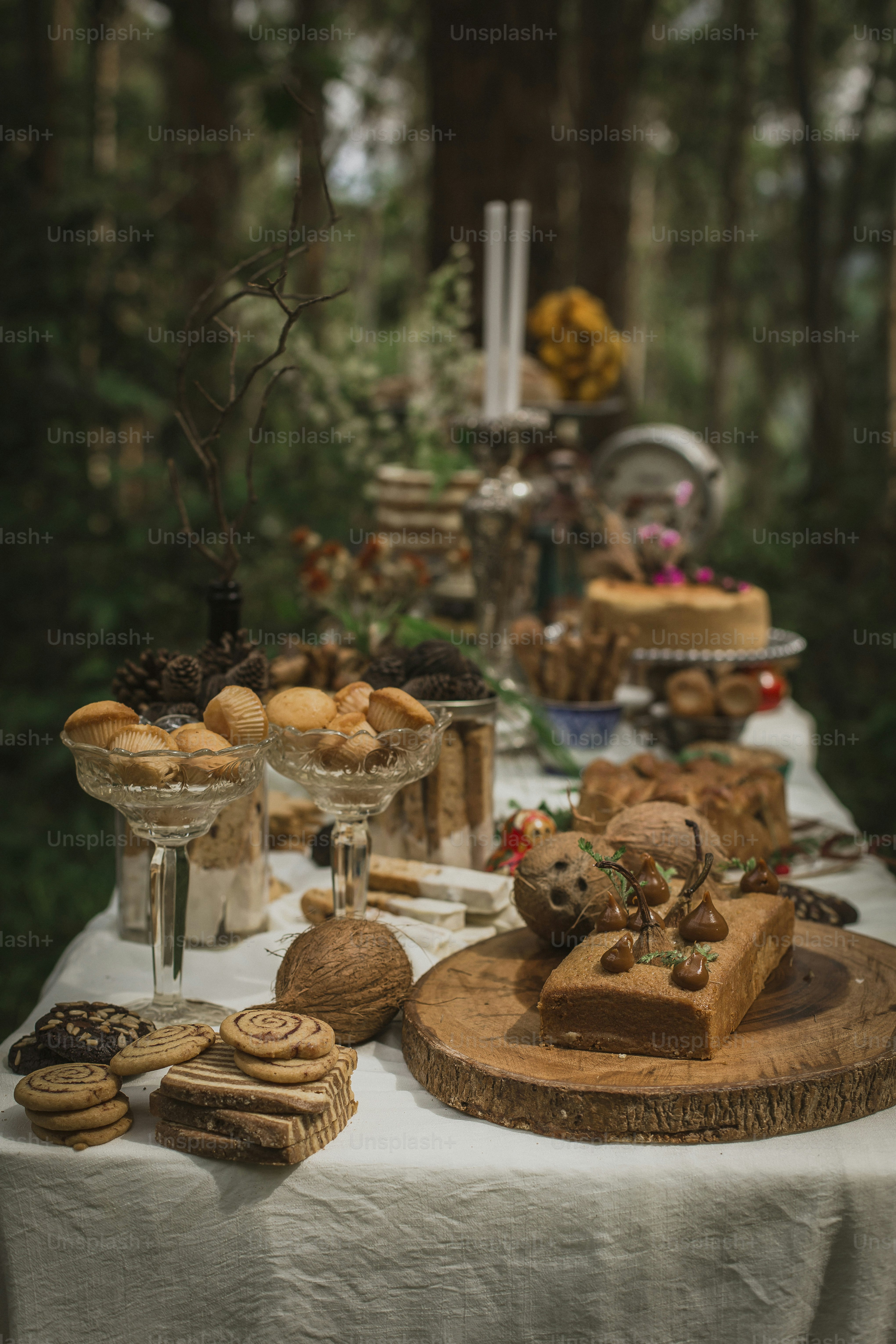 A table topped with lots of pastries and desserts photo – Food Image on ...
