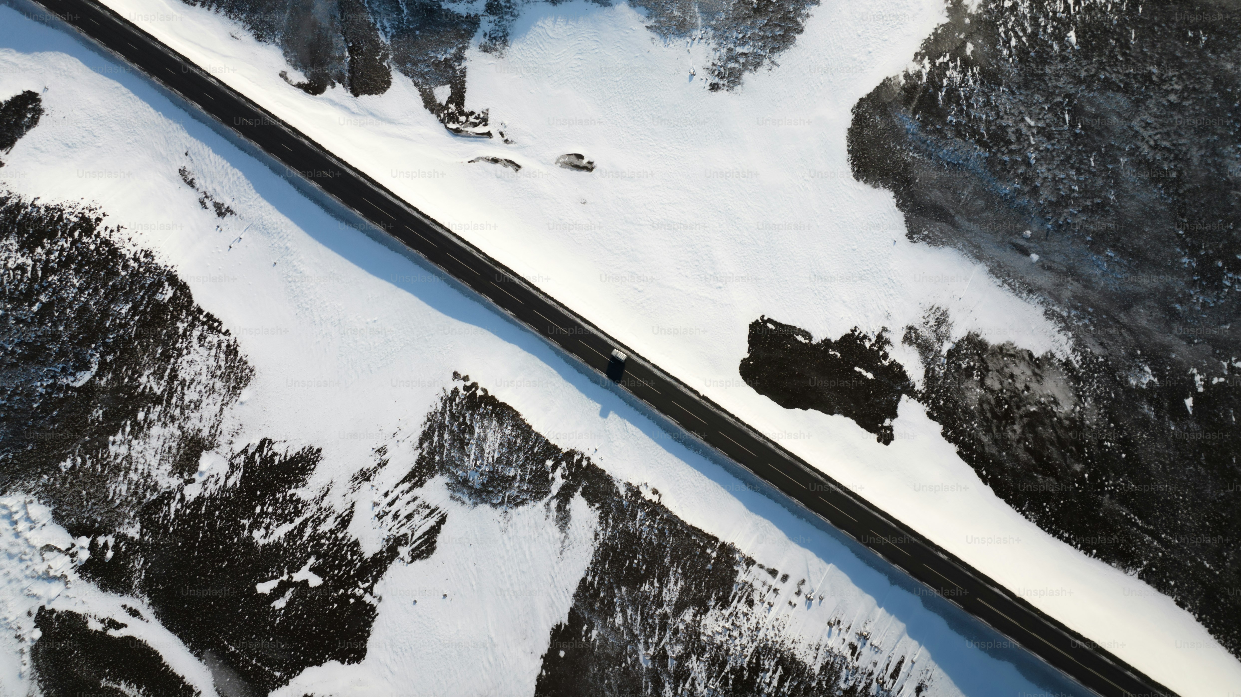 An aerial view of a train traveling through a snowy landscape photo ...