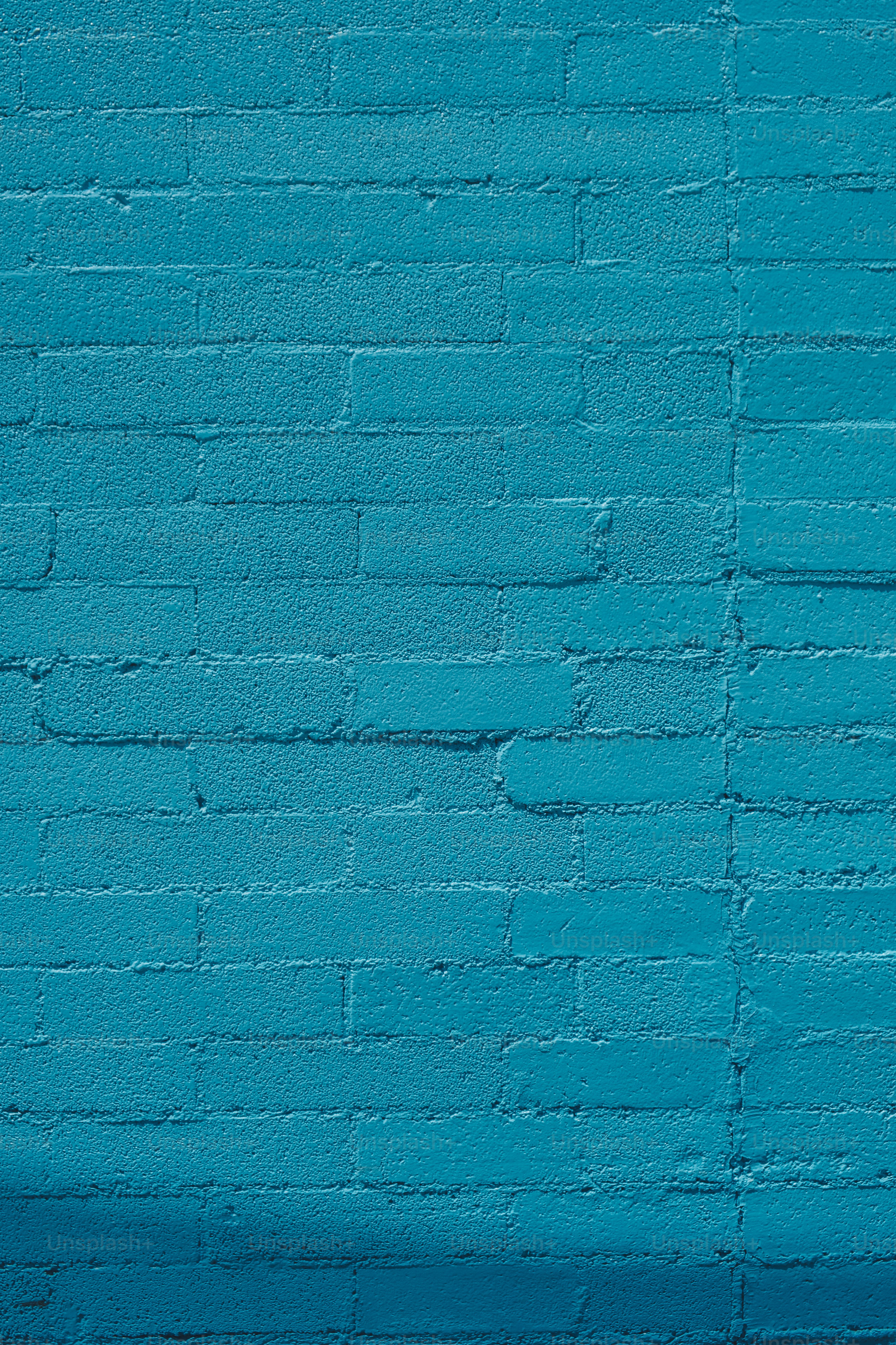 A blue brick wall with a stop sign on it photo – Wallpaper Image on ...