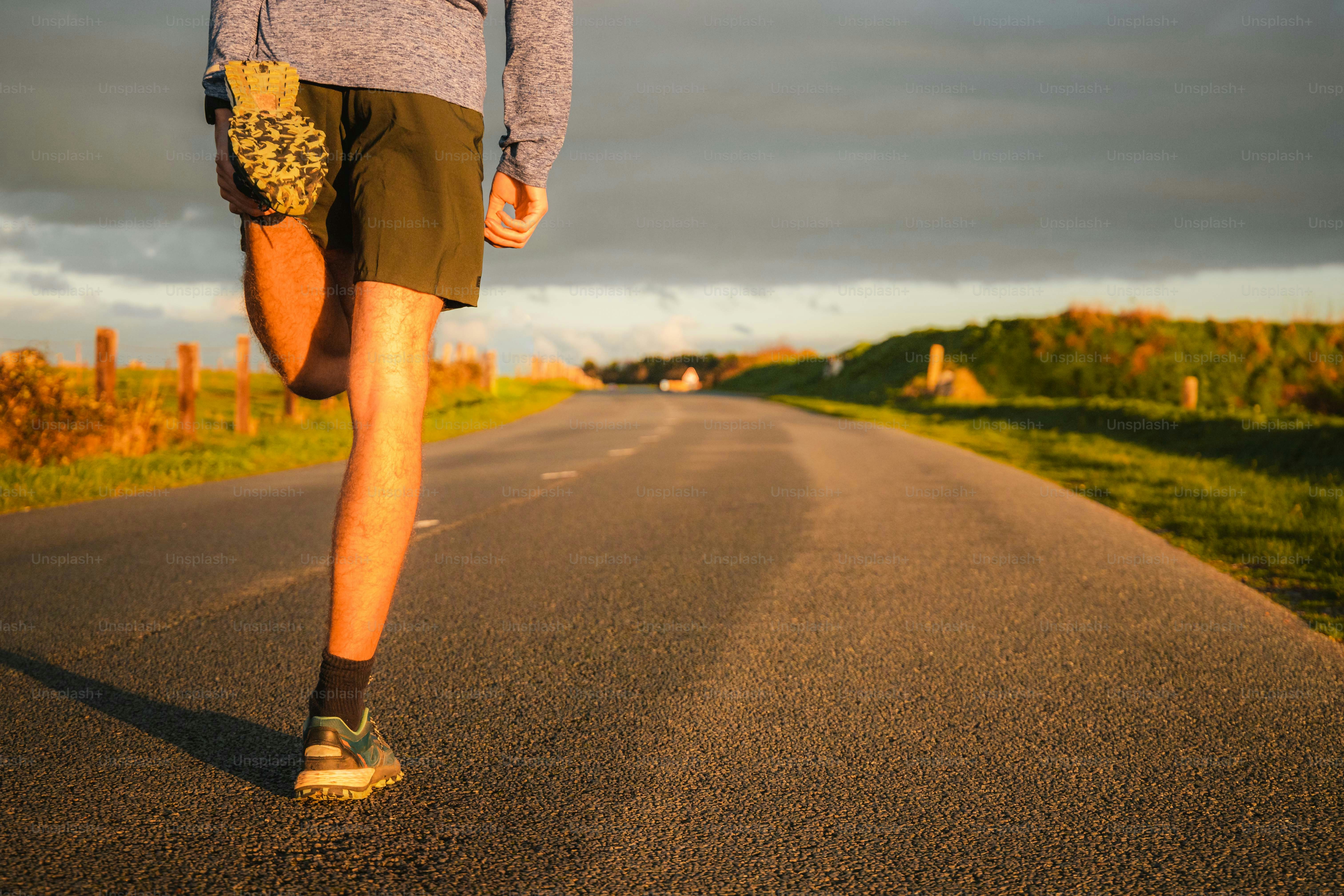A man running down a road with a sky background photo – Runner Image on ...