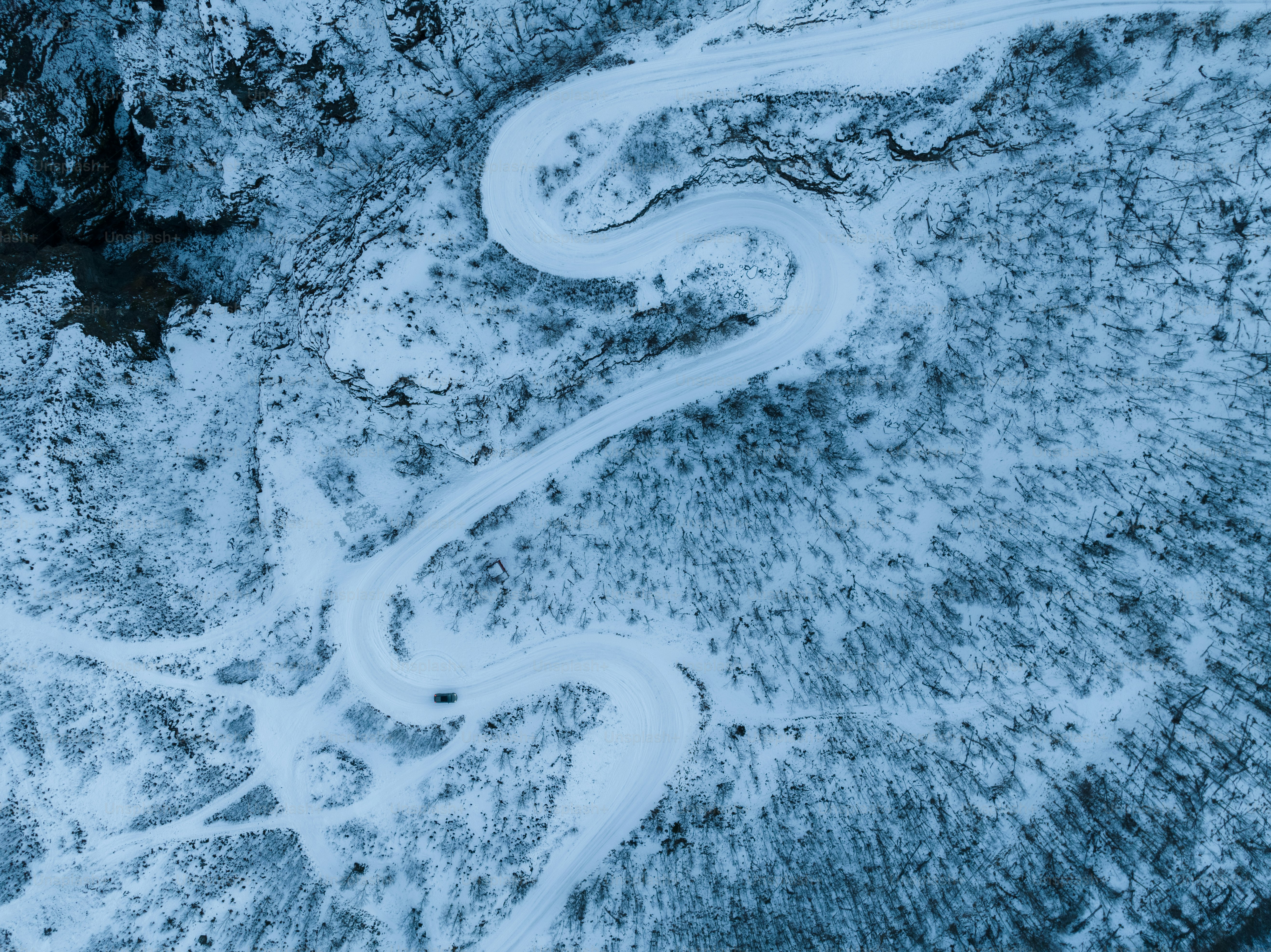 An aerial view of a winding road in the snow photo – Wallpapera Image ...