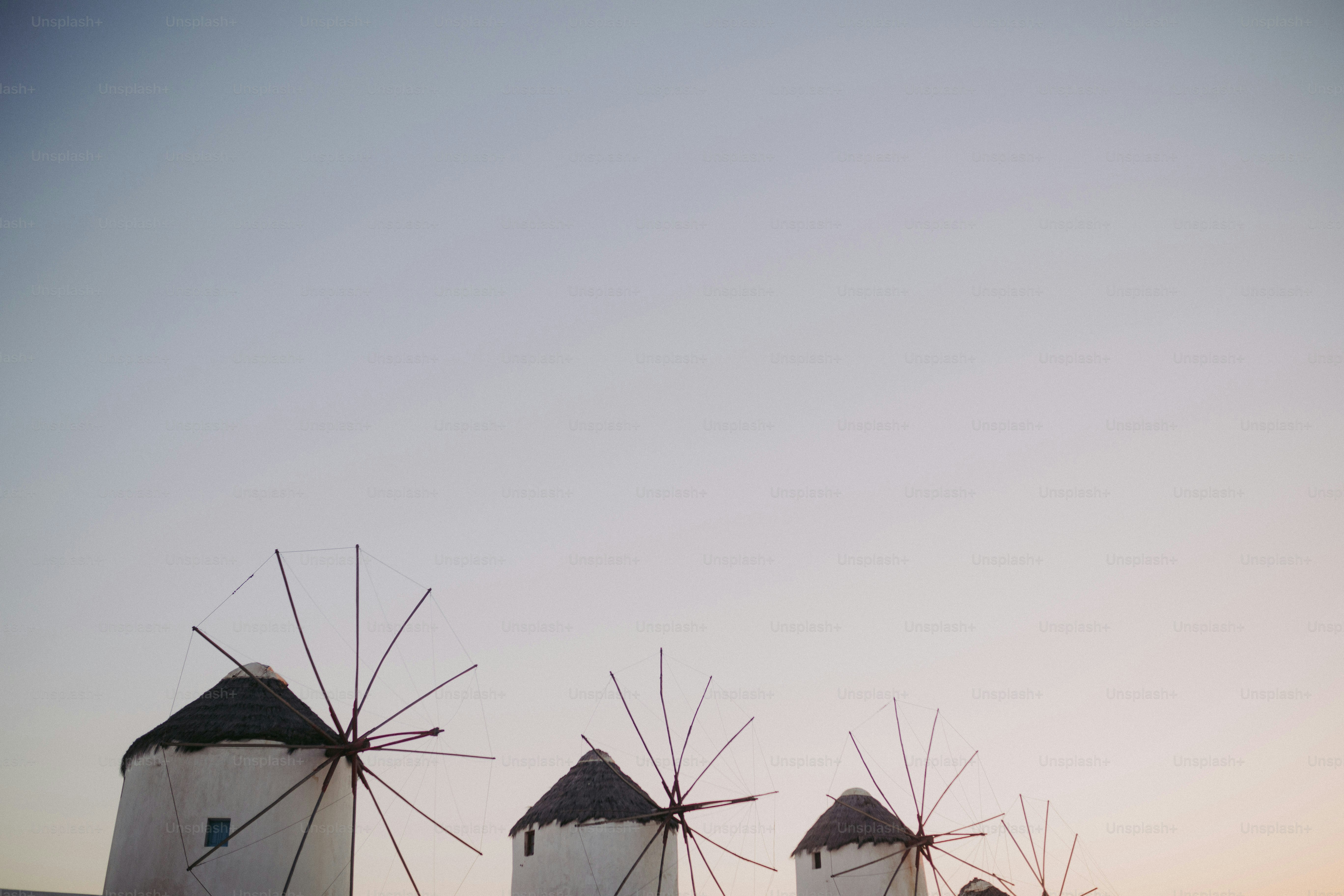 A row of white windmills sitting next to each other photo – Netherland ...