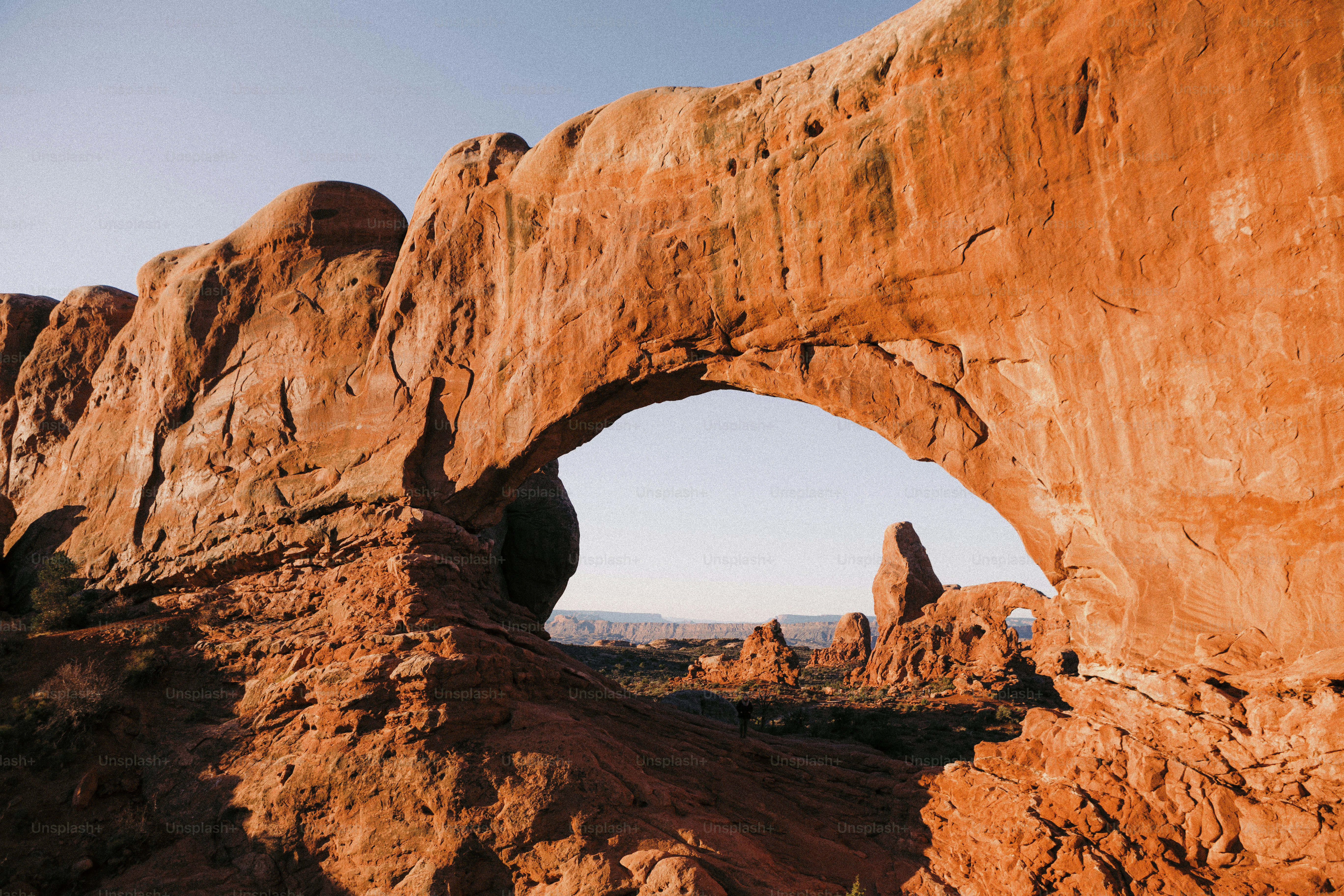 A large rock formation with a light at the end of it photo – Sky light ...
