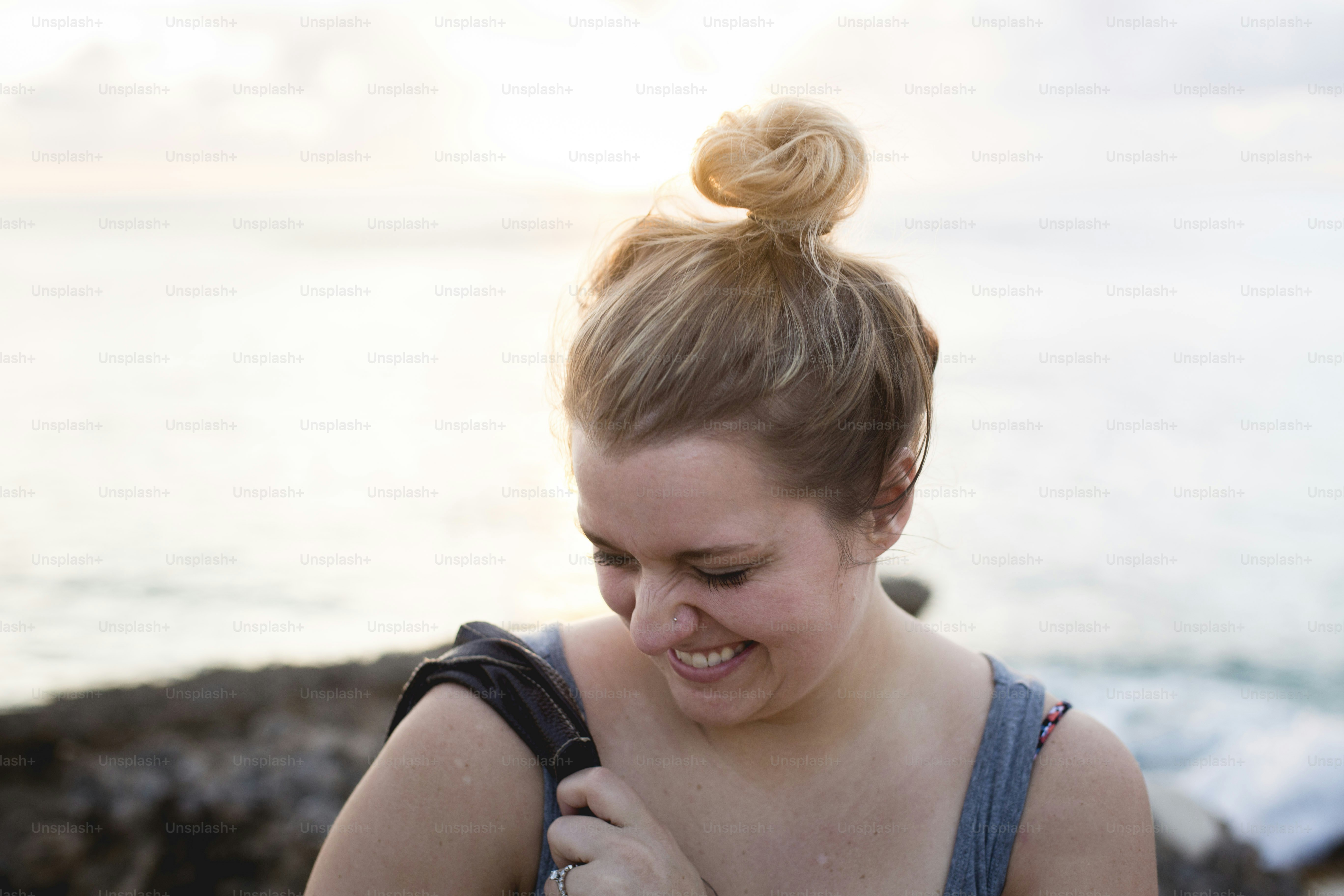 A woman standing next to a body of water photo – Blonde ecstatic people ...