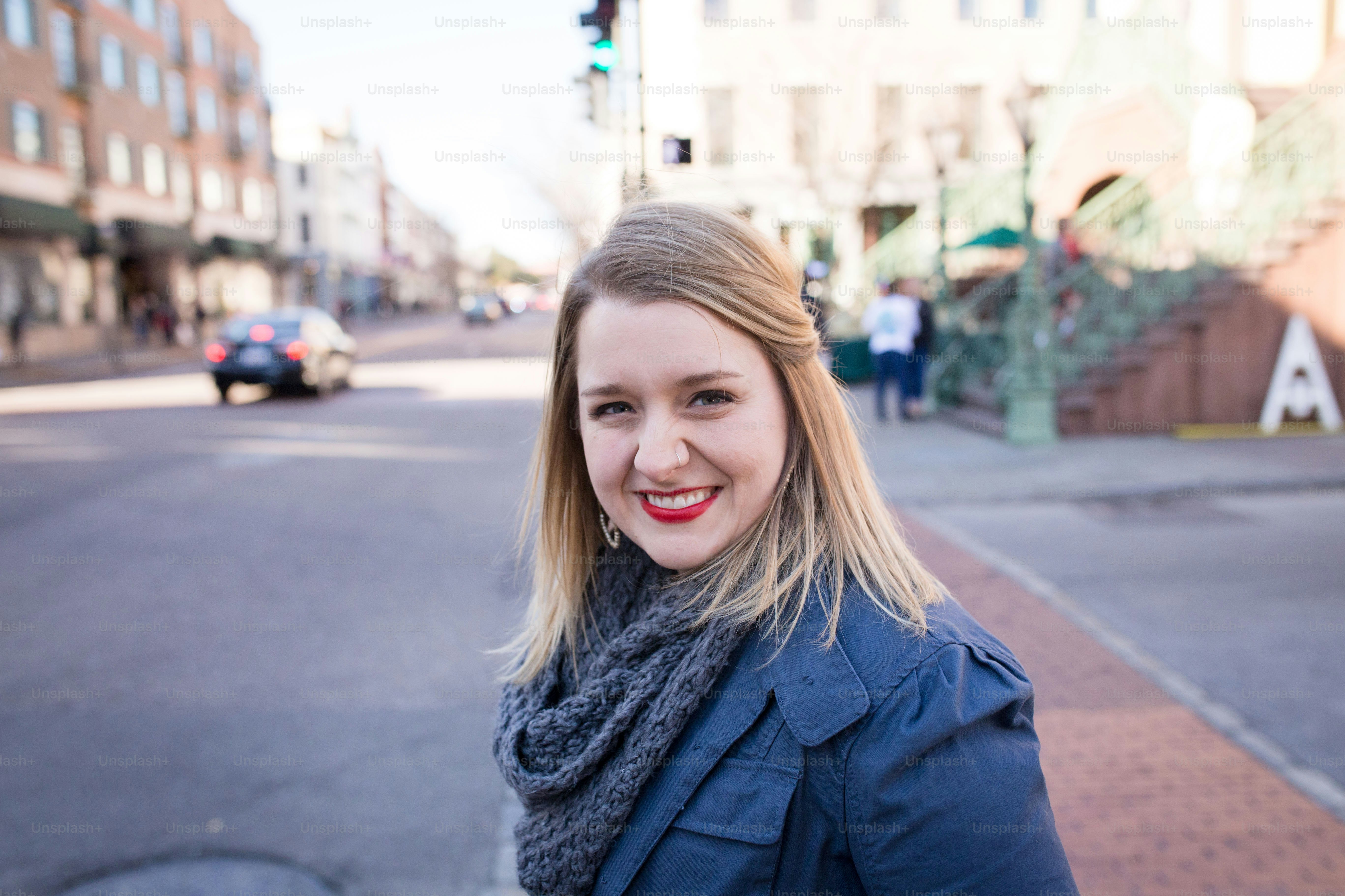 A woman standing in the middle of a street photo – Portrait Image on ...