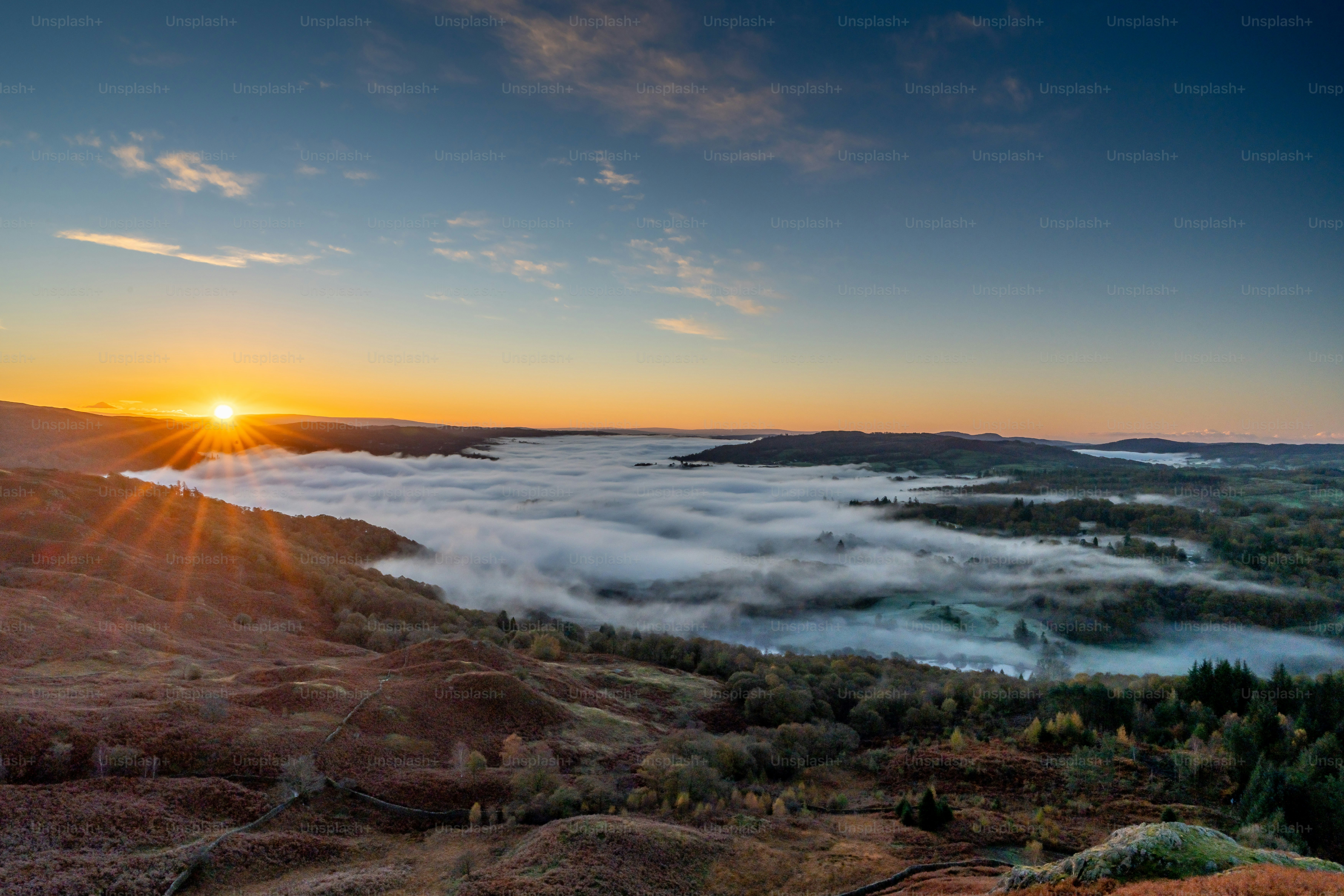 The sun is setting over the clouds in the valley photo – Sunrise ...