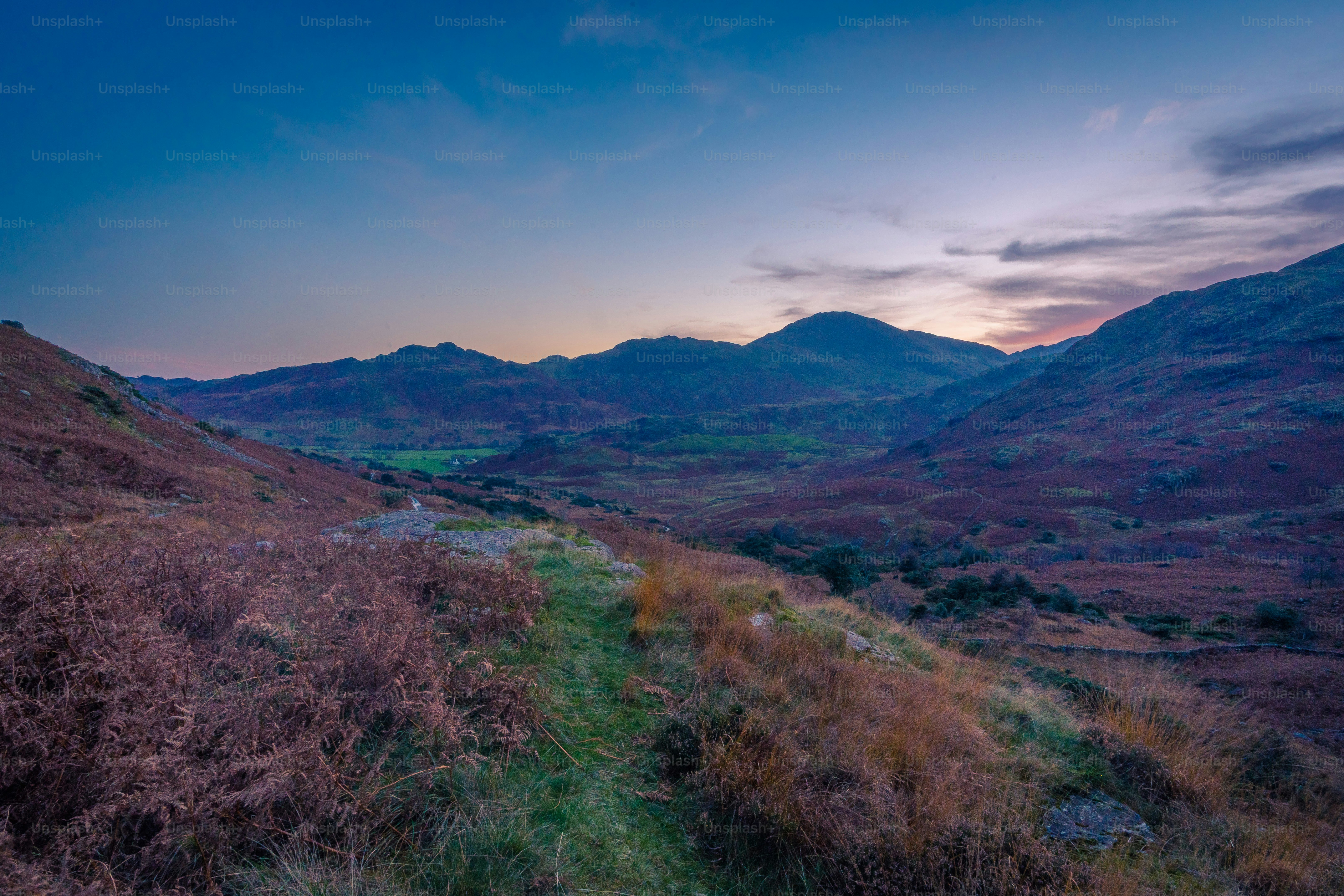 A view of a valley with mountains in the background photo – Ambleside ...