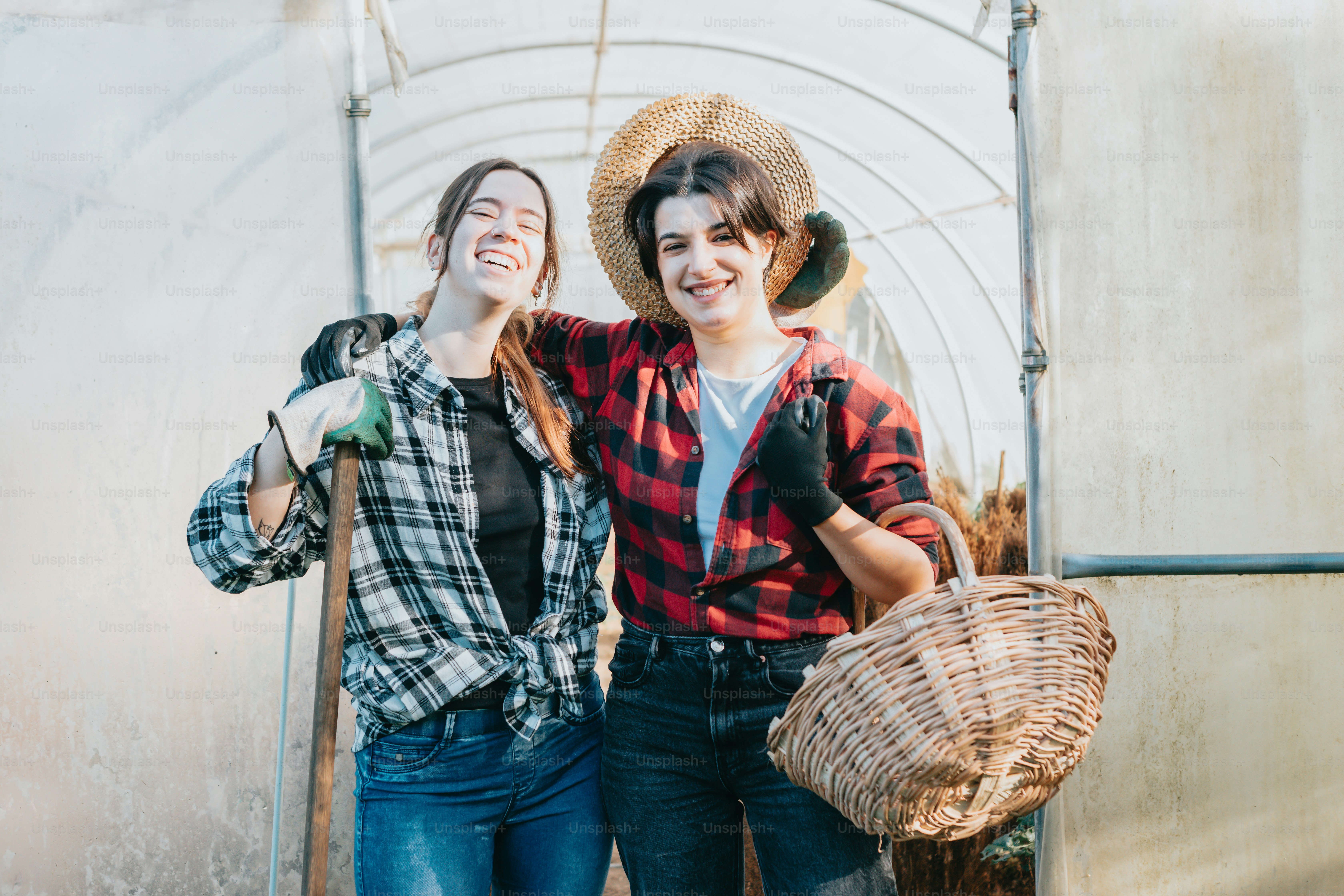 Two women standing next to each other holding baskets photo ...