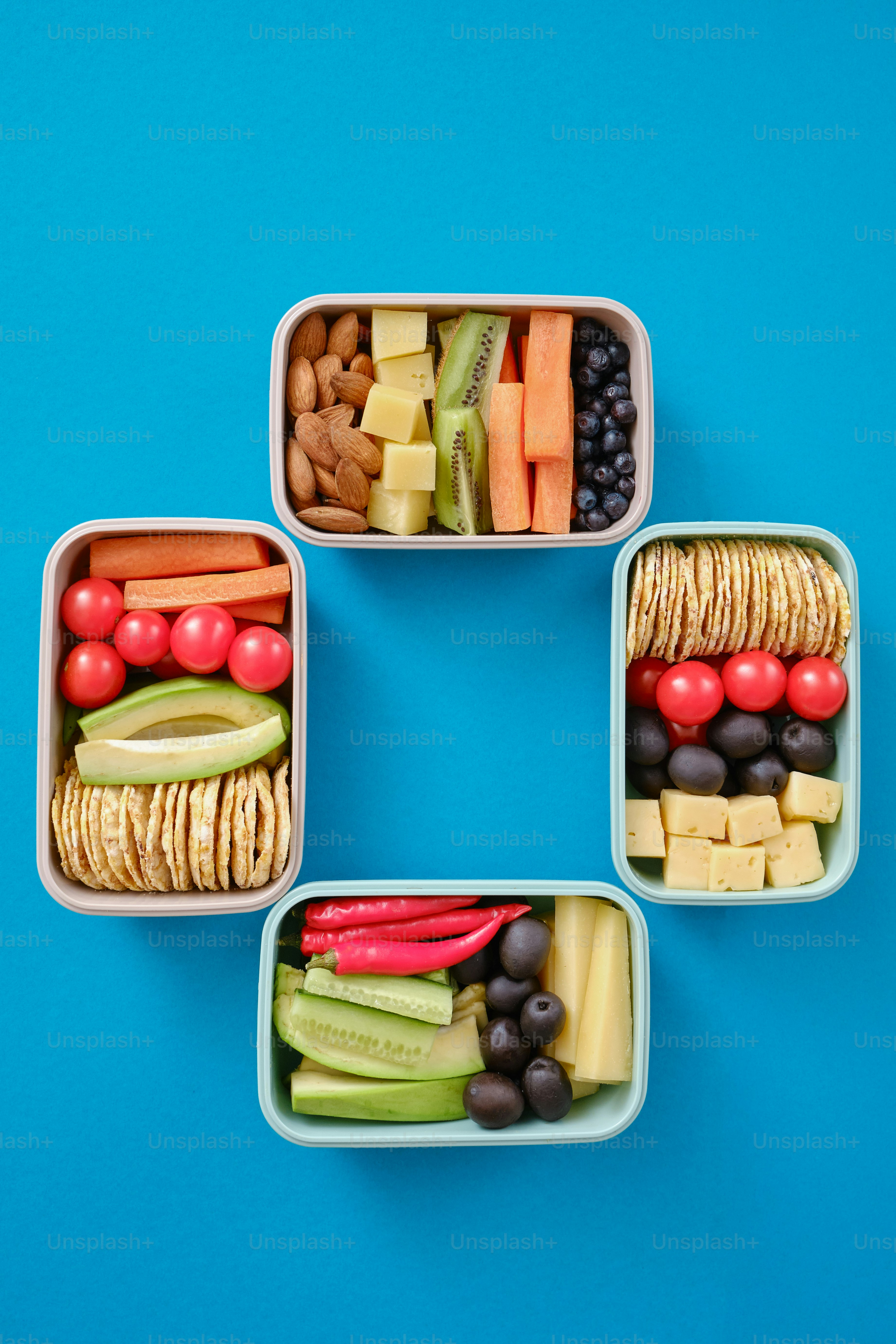 A group of four containers filled with different types of food photo ...