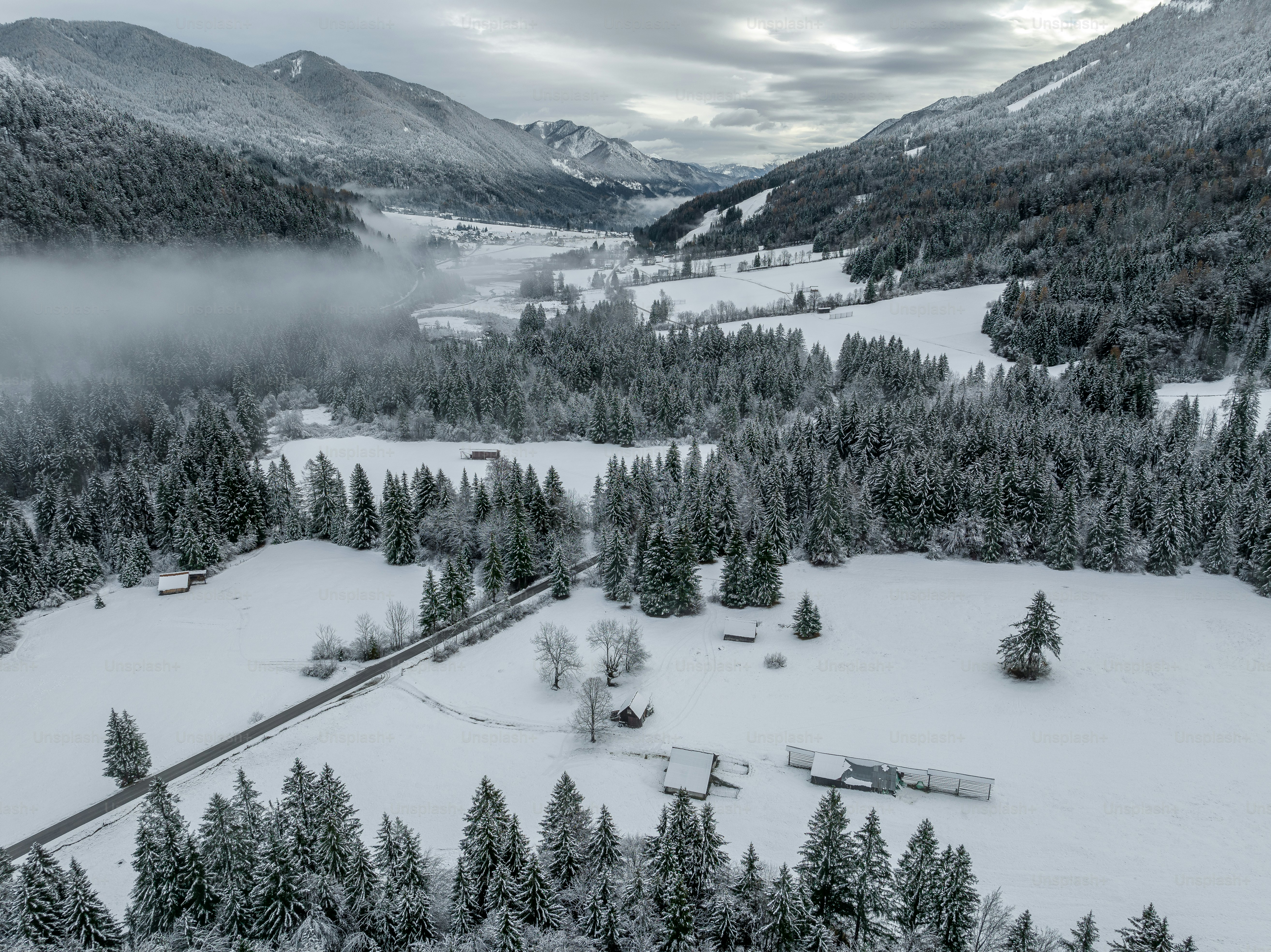 An aerial view of a snowy mountain valley photo – Winter Image on Unsplash