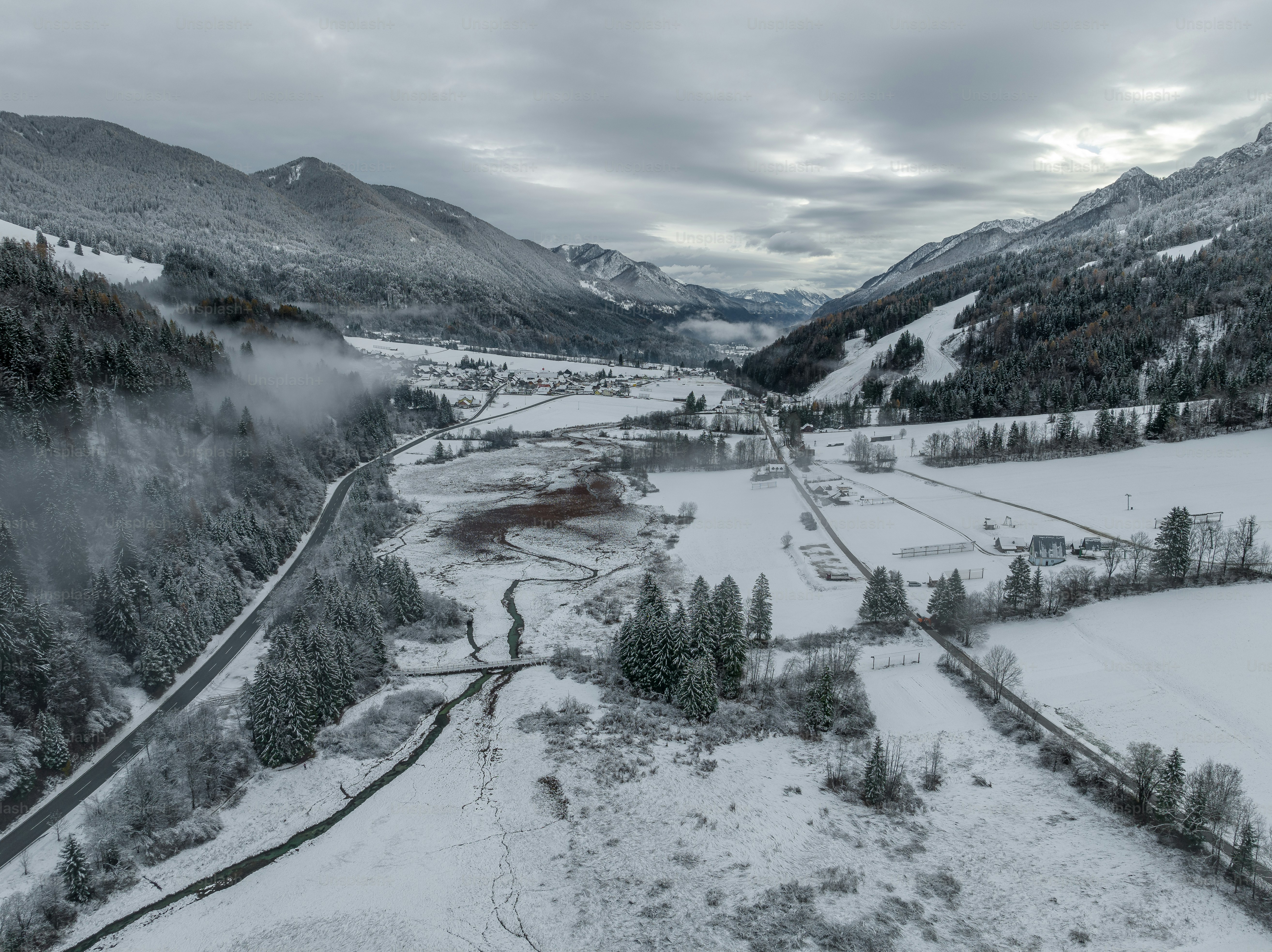An aerial view of a snowy mountain valley photo – Nature Image on Unsplash