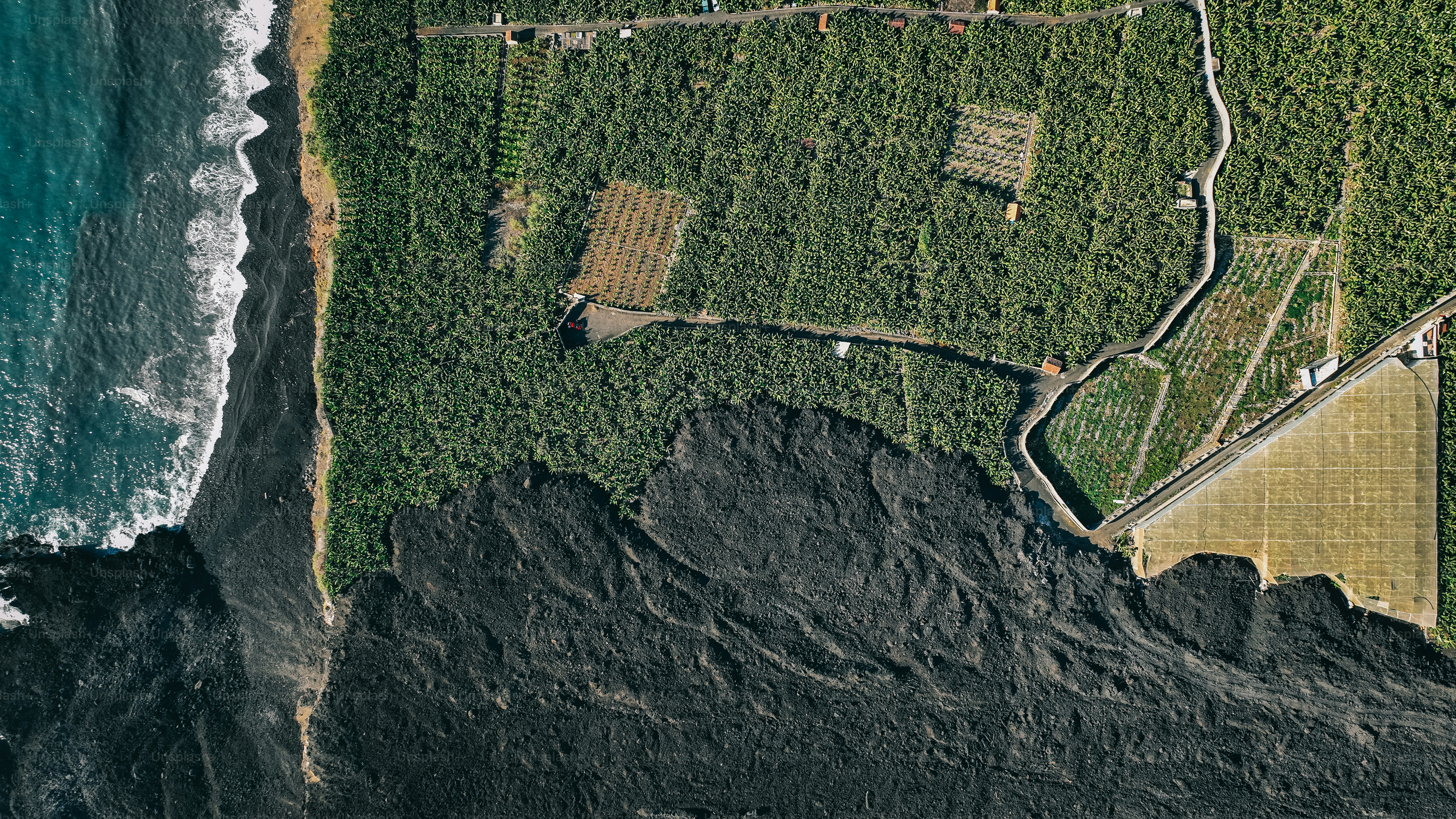 An aerial view of a lush green area next to the ocean photo – Spain ...