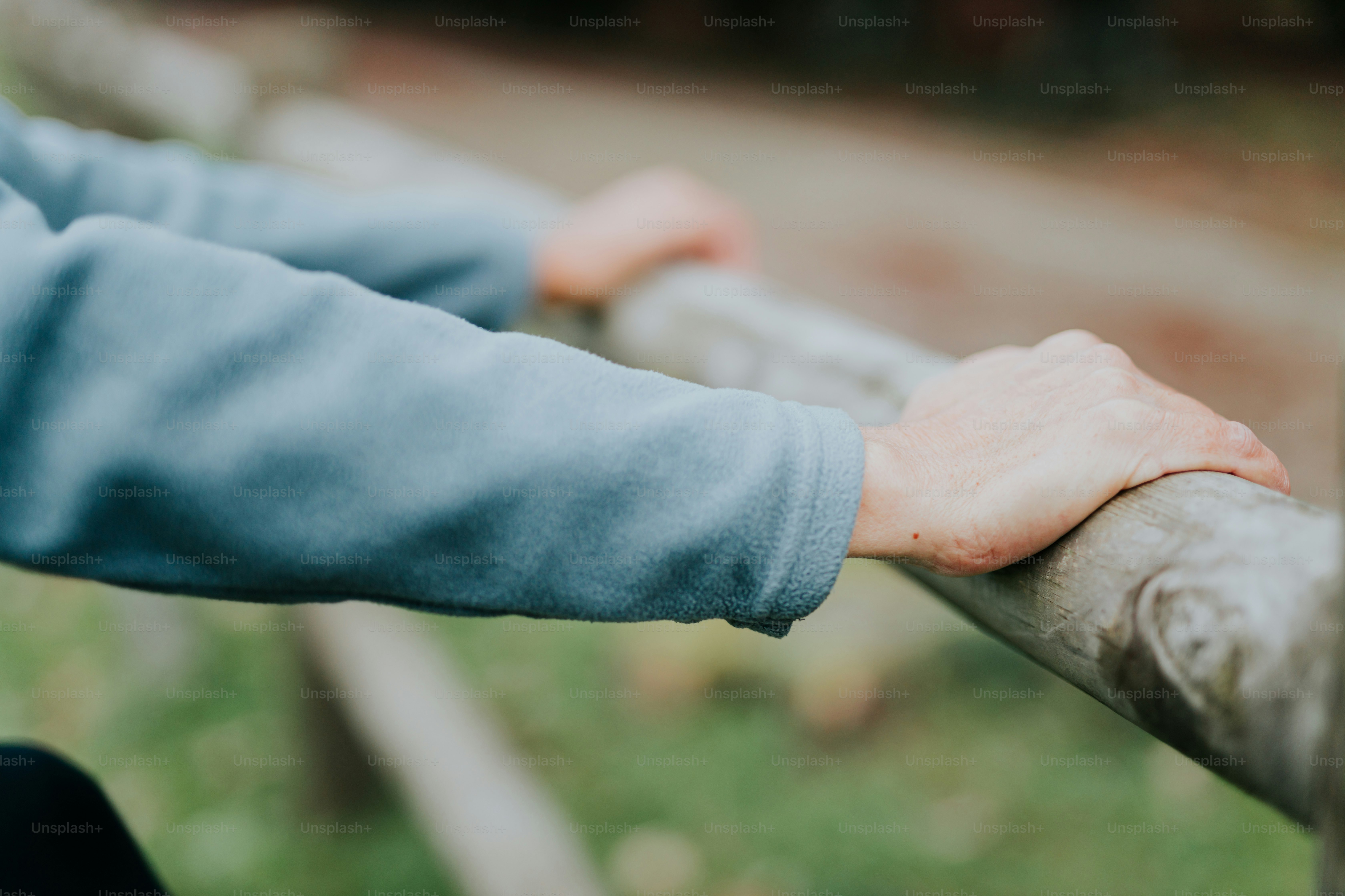 A person holding onto a rail with their hand photo – Excising Image on ...