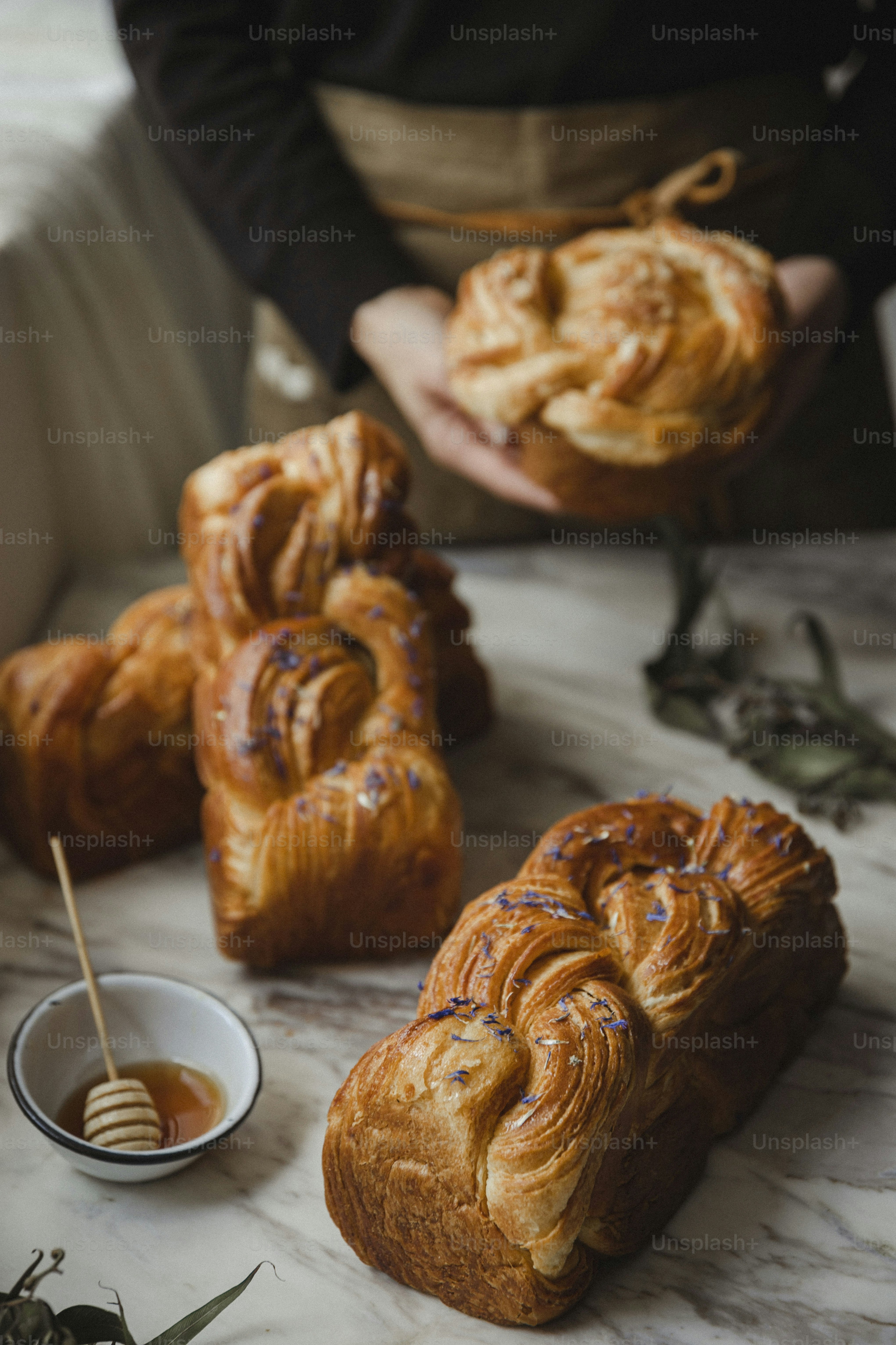 A table topped with pastries and a bowl of honey photo – Food Image on ...