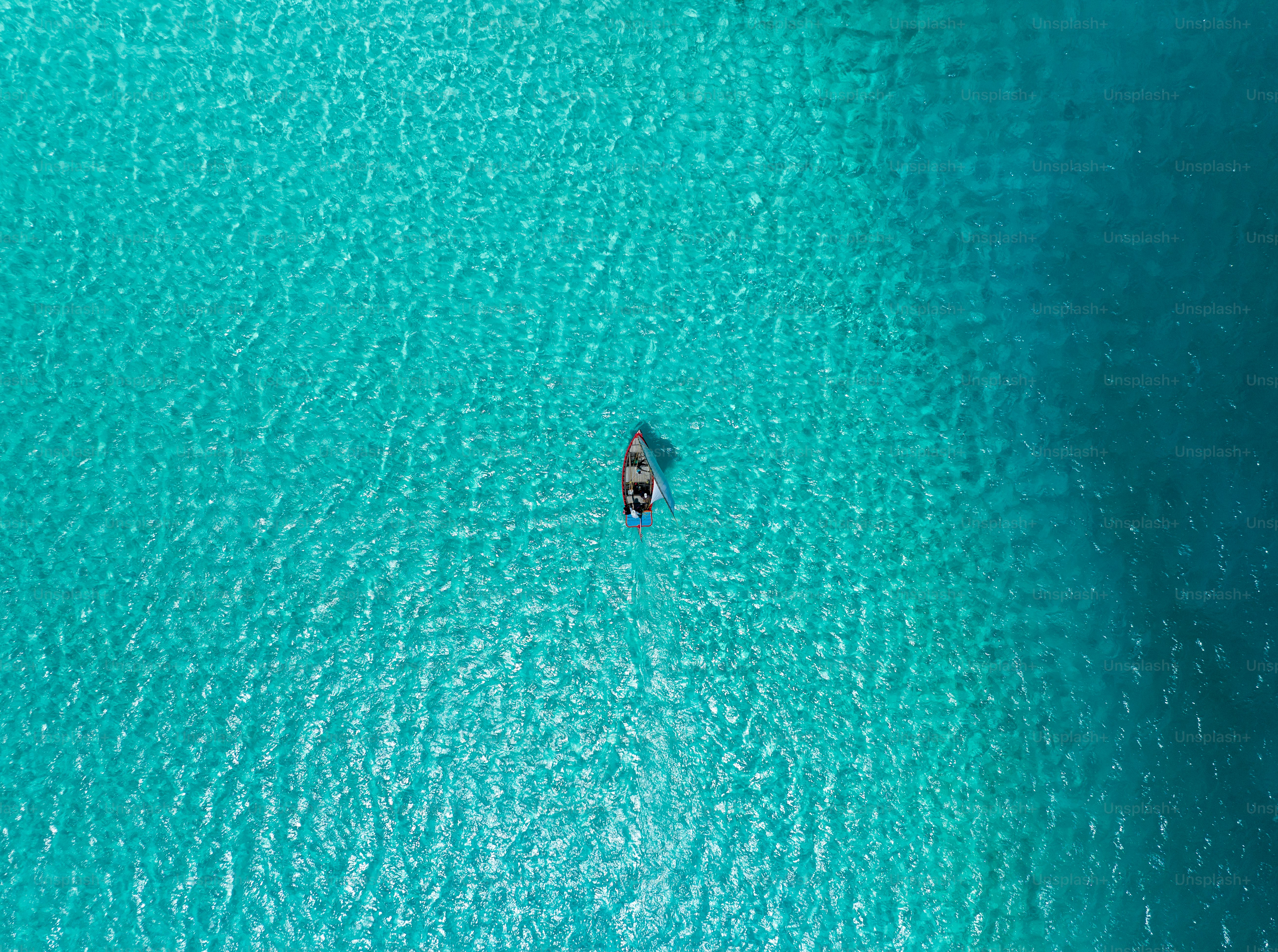 A person in a boat in the middle of the ocean photo – Ocean Image on ...