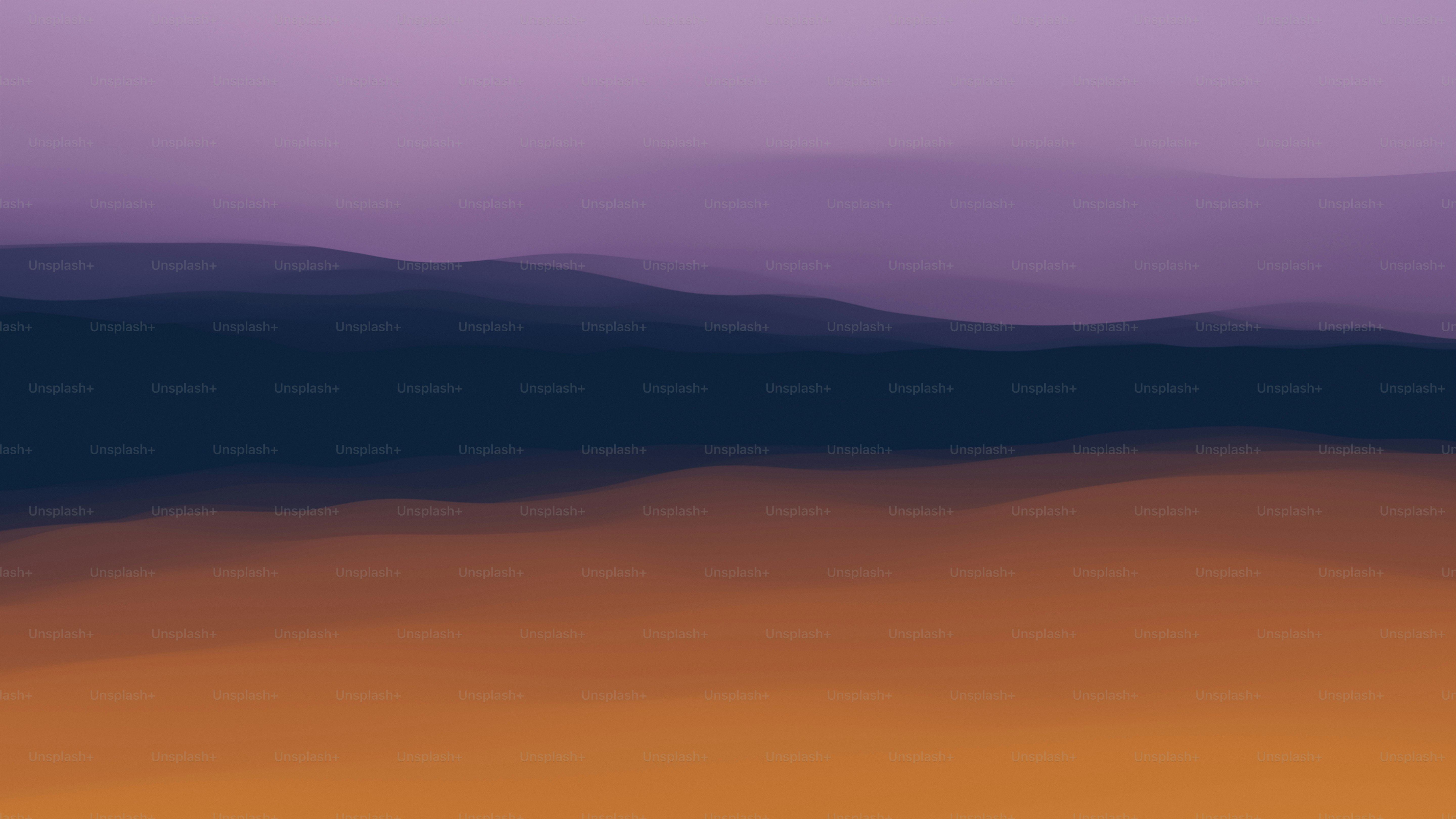 A purple and orange landscape with mountains in the background photo ...