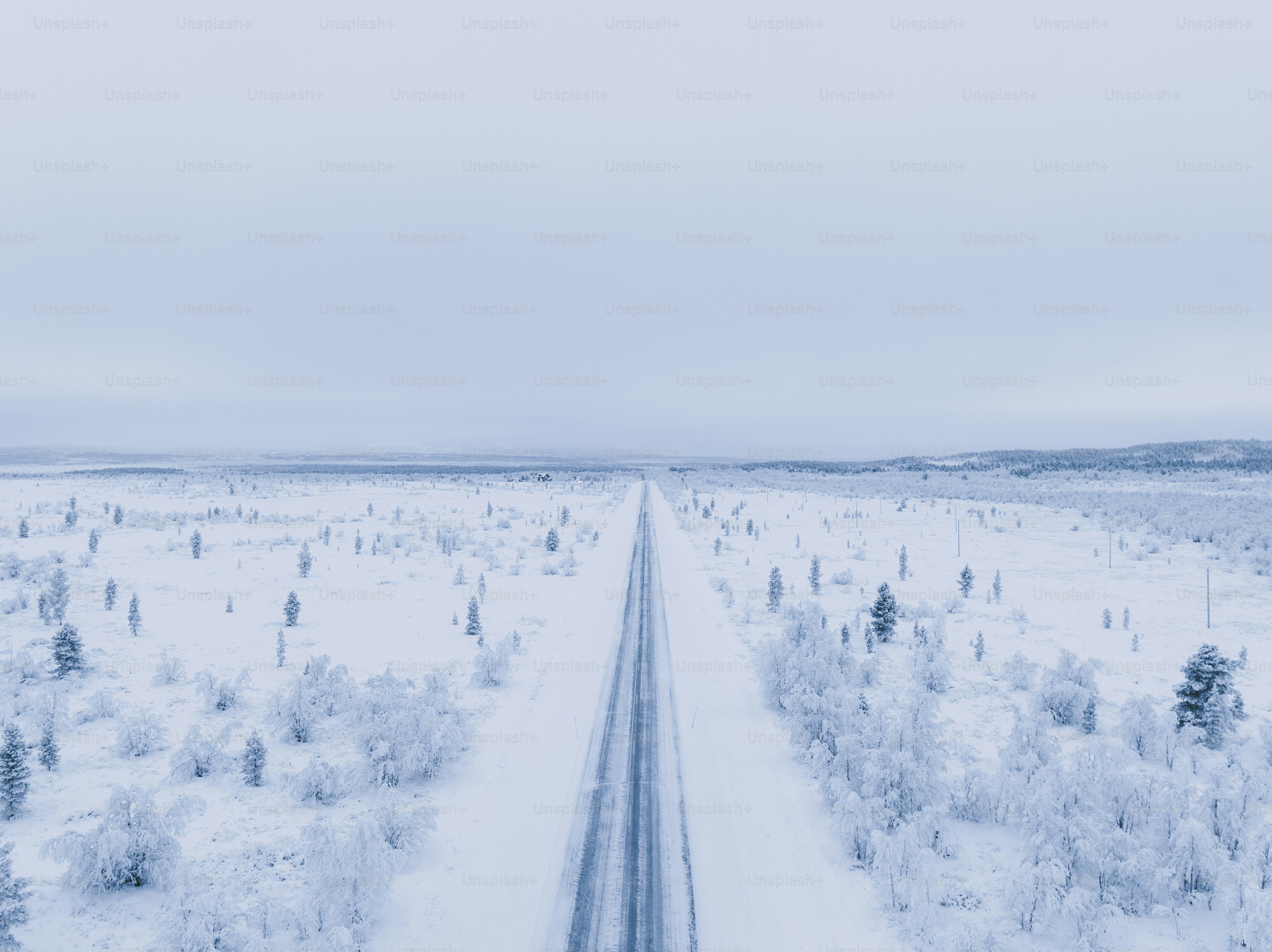 An aerial view of a snow covered area photo – Land and sky Image on ...