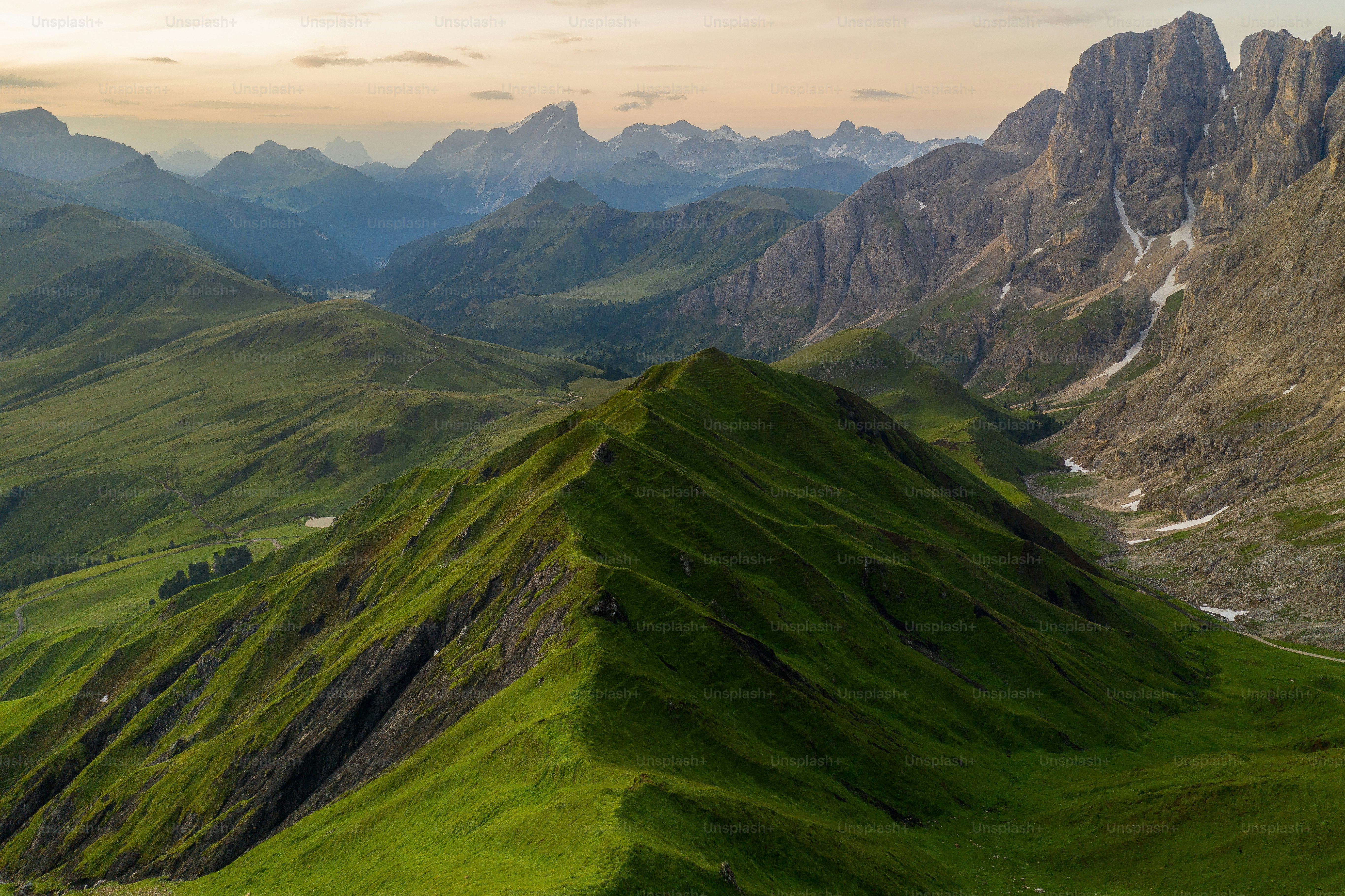 A valley with mountains in the background photo – Image on Unsplash