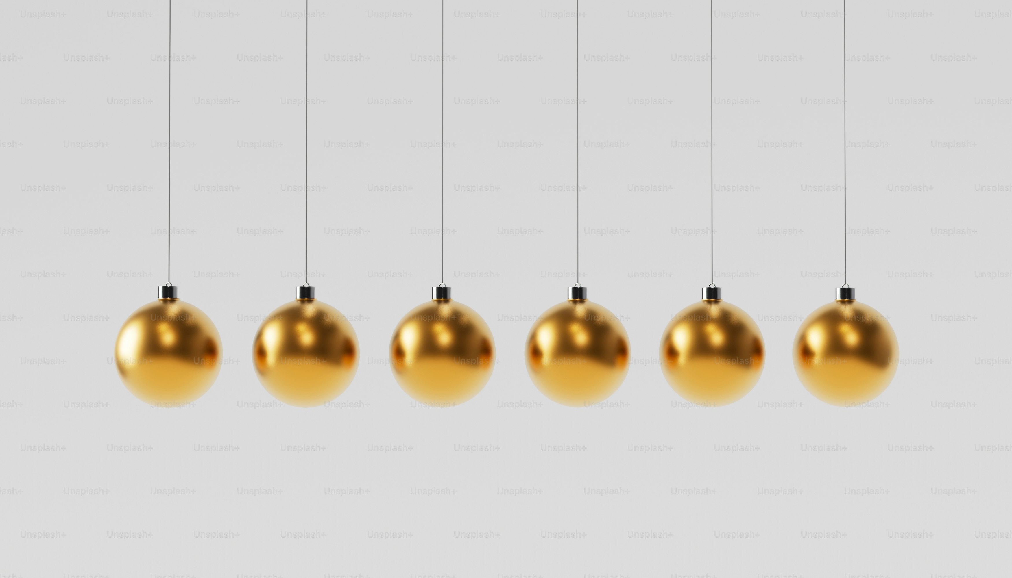 A group of gold balls hanging from a line photo – Baubles Image on Unsplash