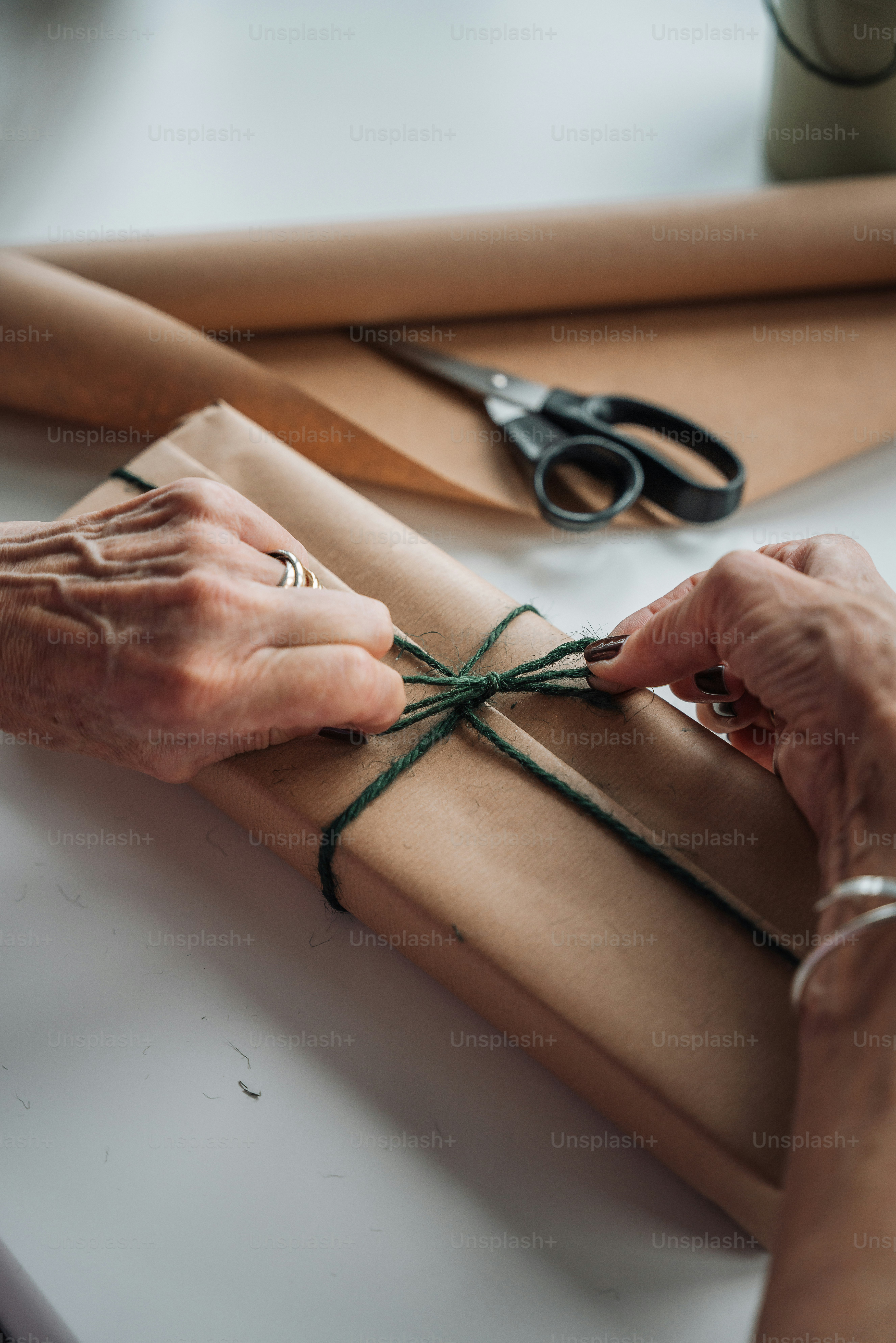A person cutting a green string photo – Wrapping Image on Unsplash