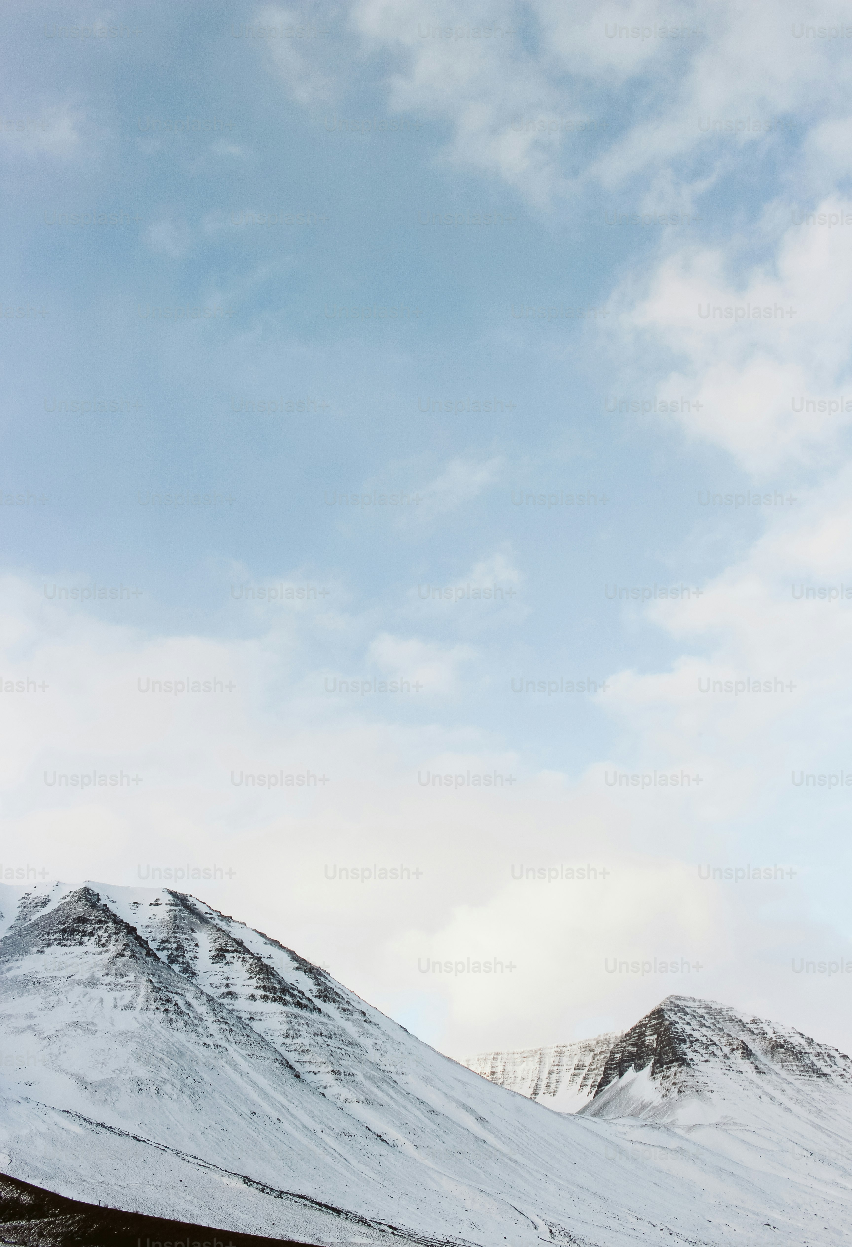 A snowy mountain with clouds photo – Phone background Image on Unsplash