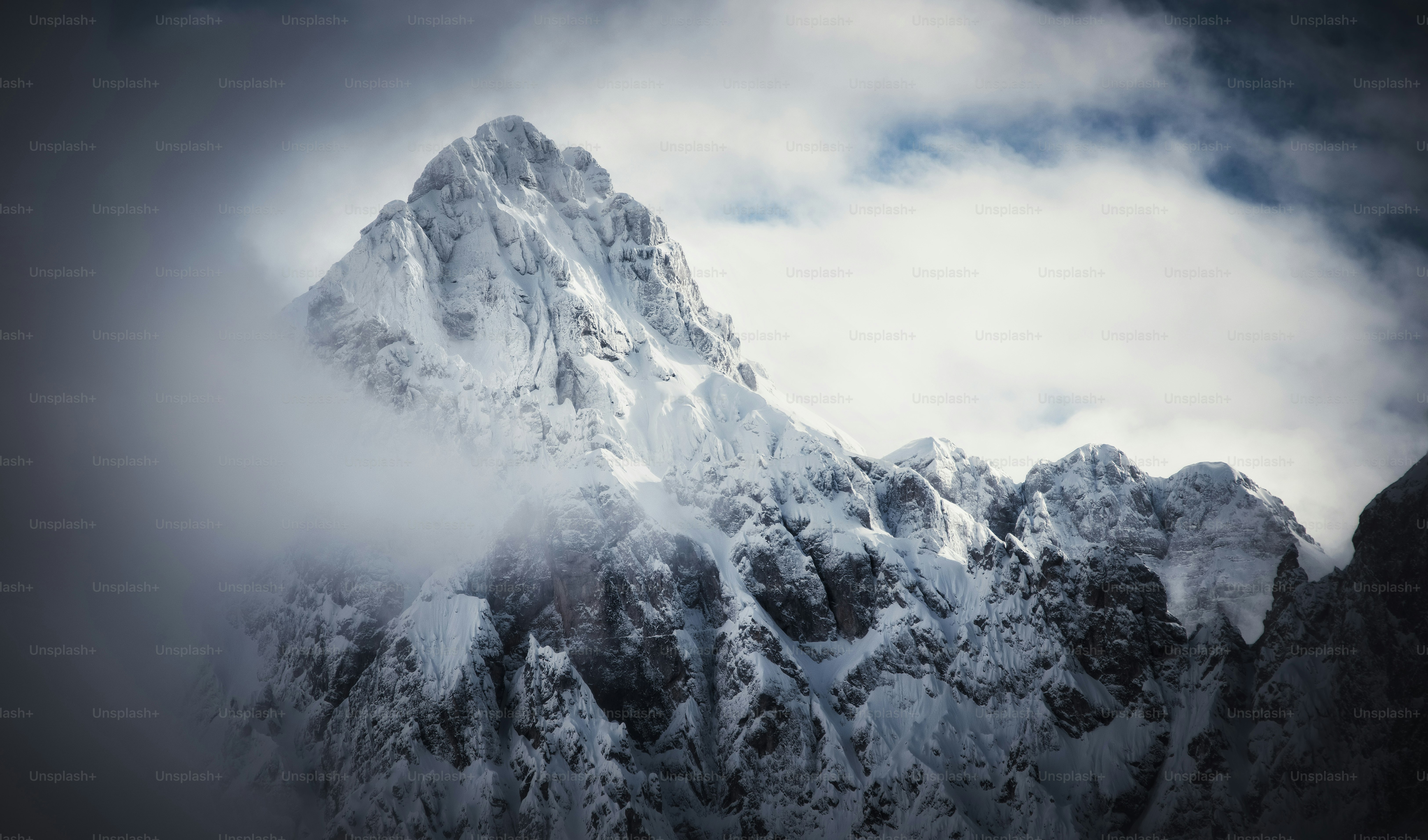 A mountain covered in snow photo – Misty mountains Image on Unsplash