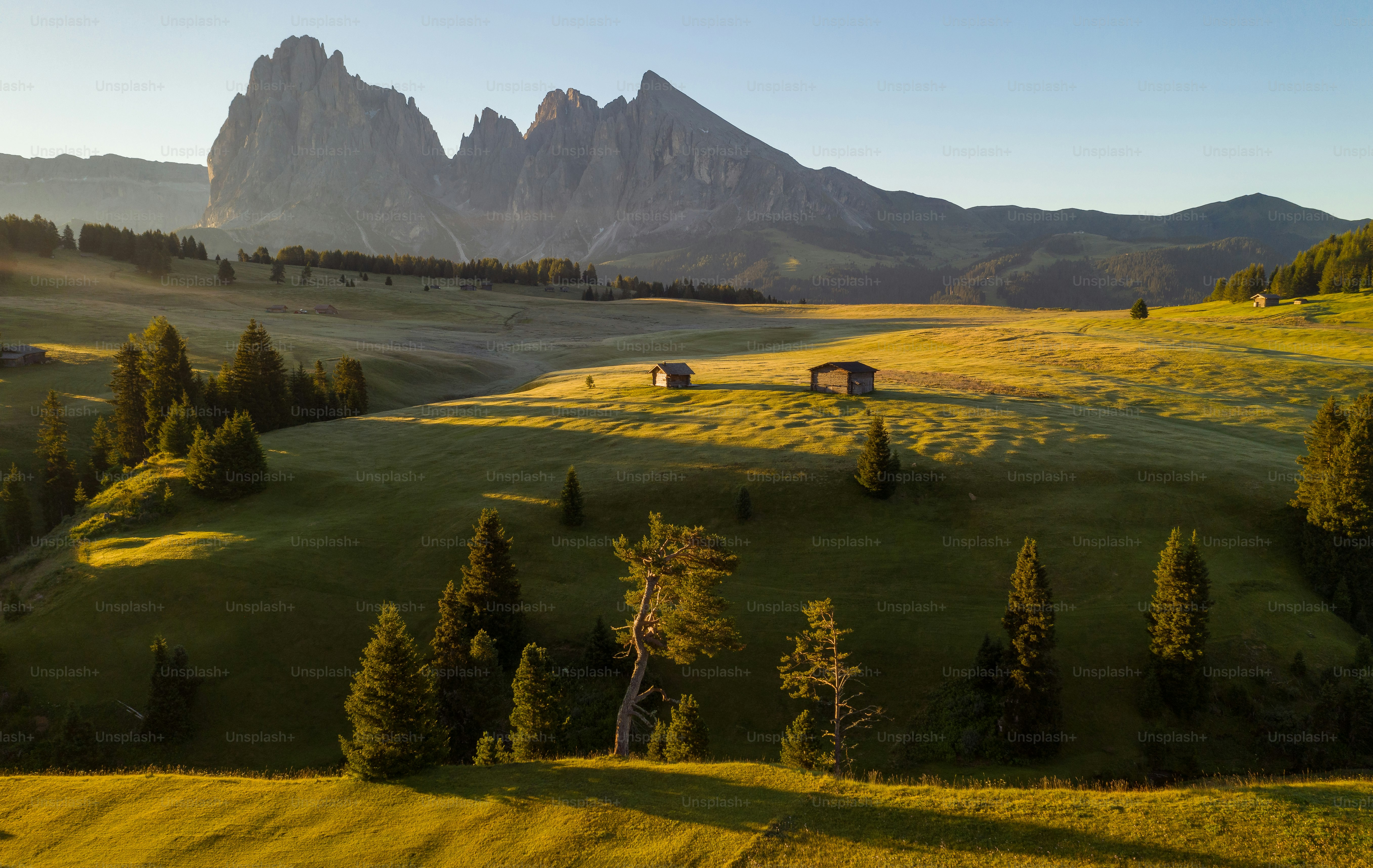 A landscape with trees and mountains in the background photo – Sunset ...