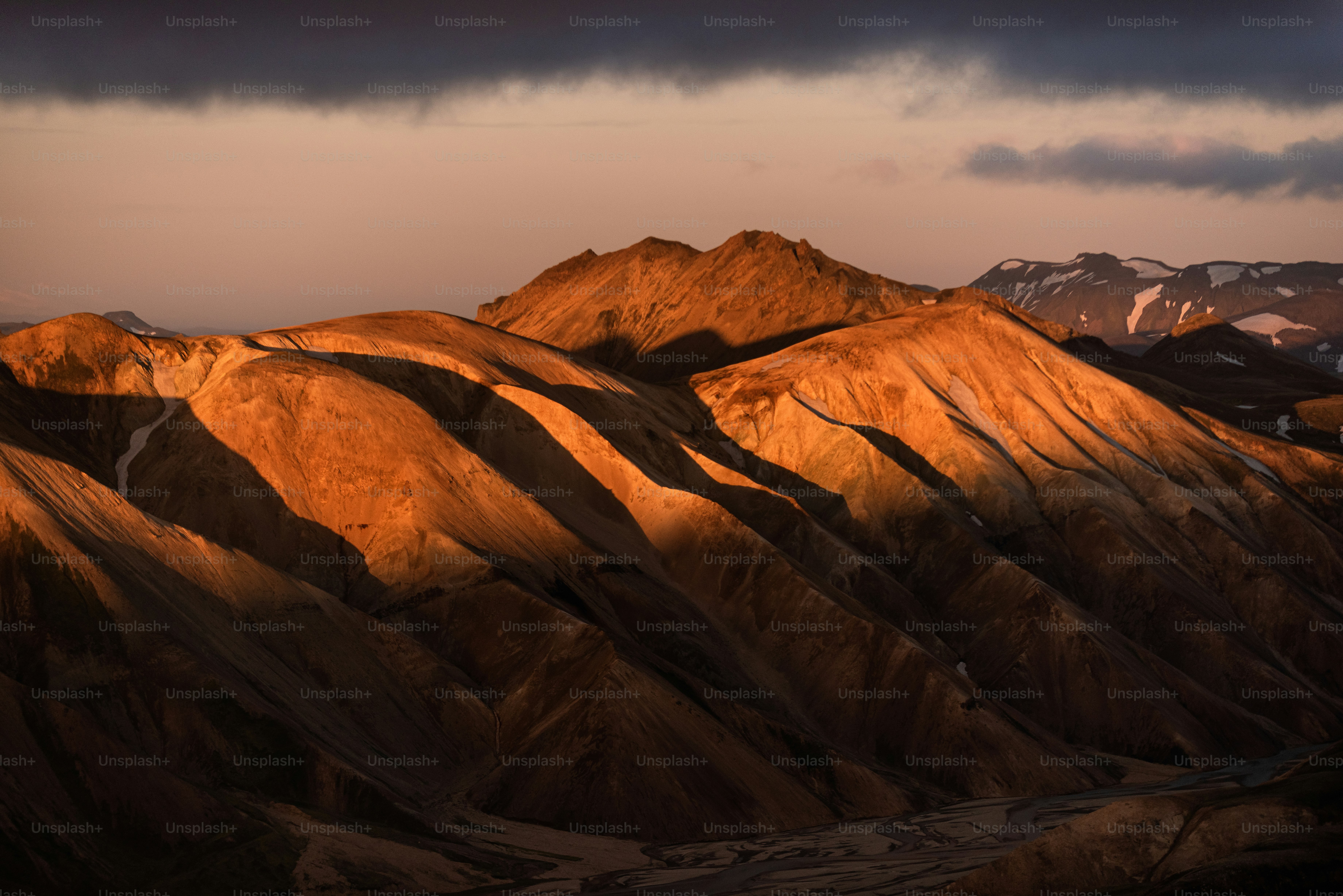 A person walking on a path by a body of water photo – Beach Image on ...