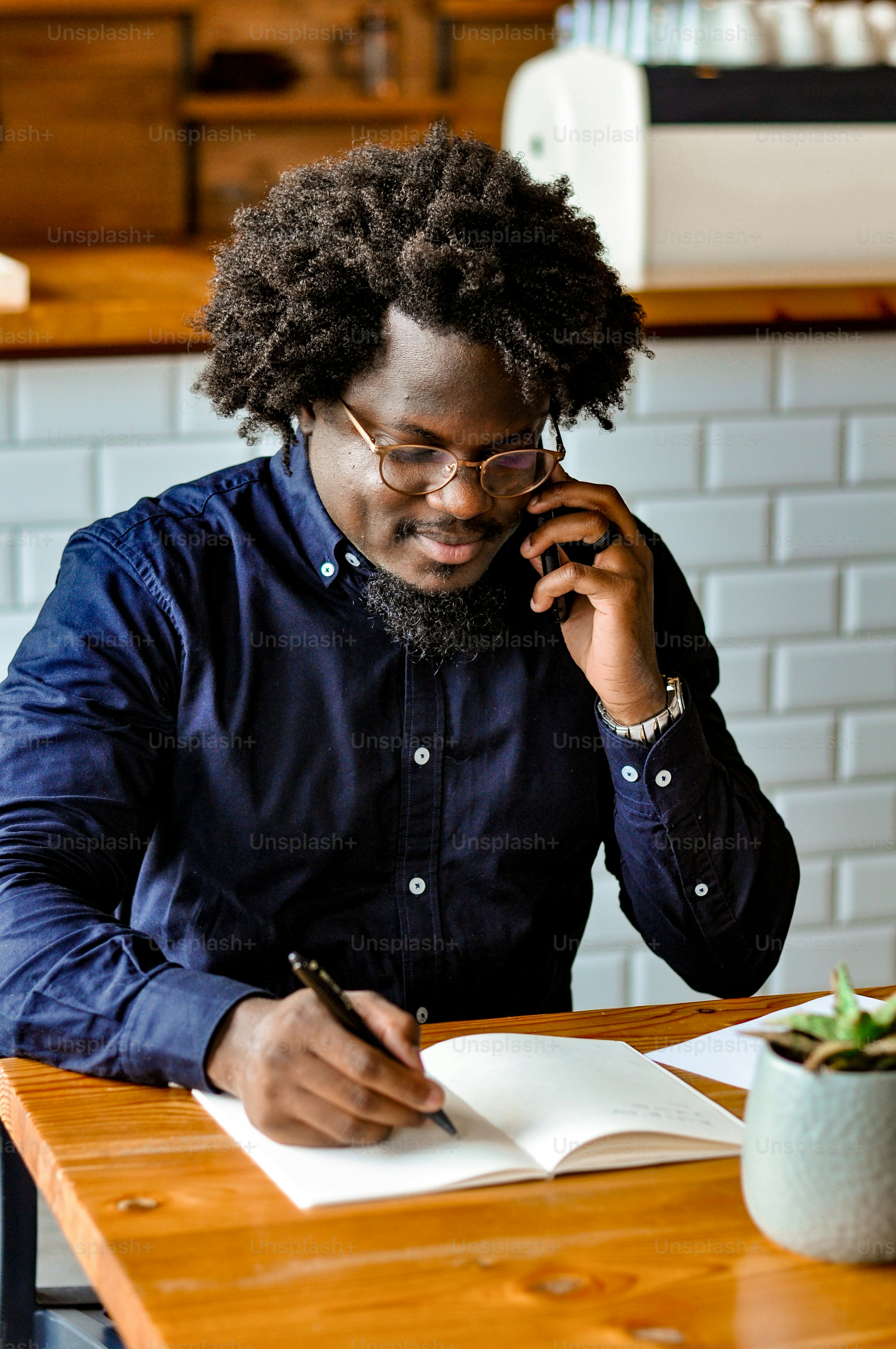 A man holding a pen and a paper photo – Black model Image on Unsplash