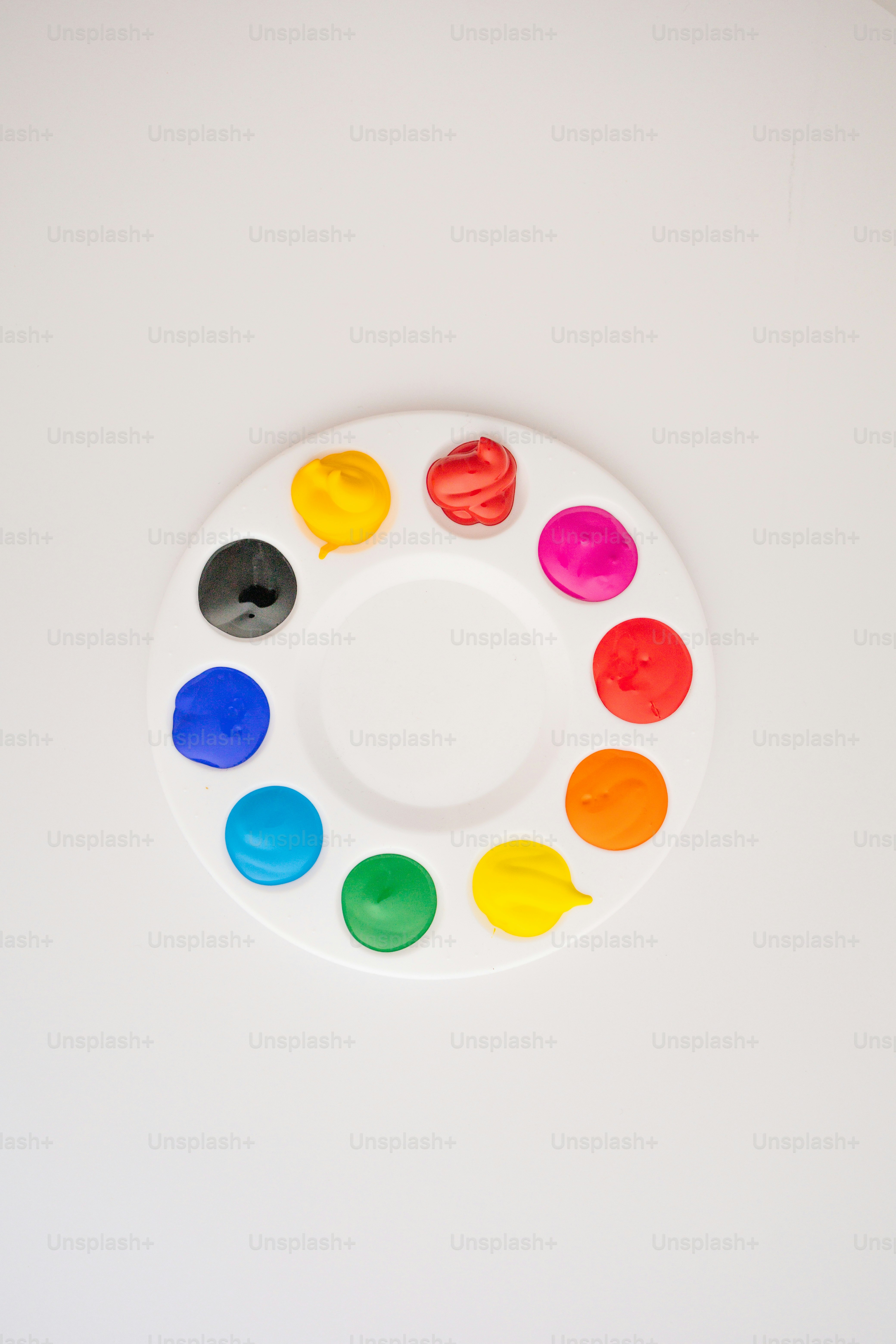 A white plate with colorful round objects on it photo – Texture Image ...