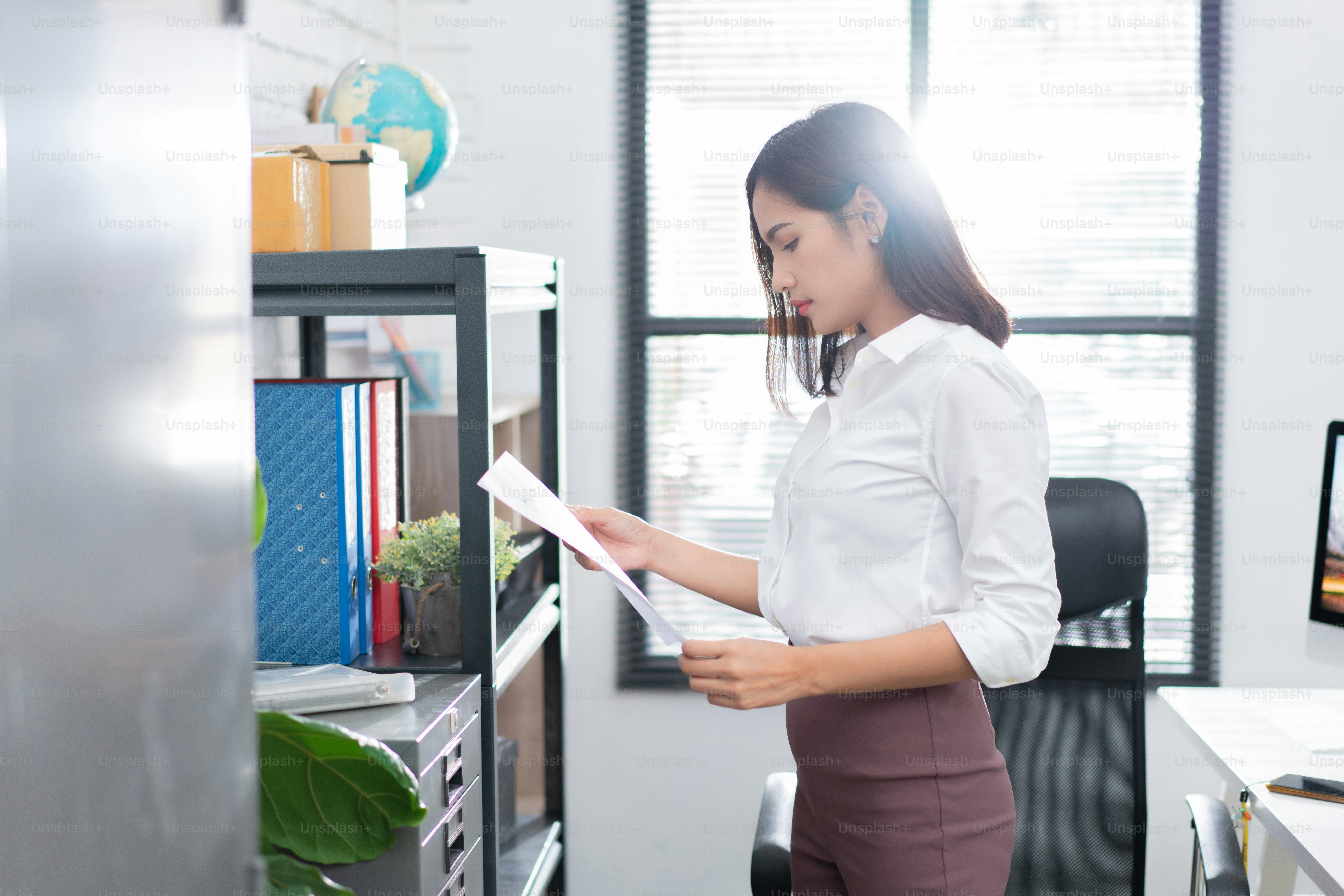 Asian women viewing documents in the office. photo – Asia Image on Unsplash