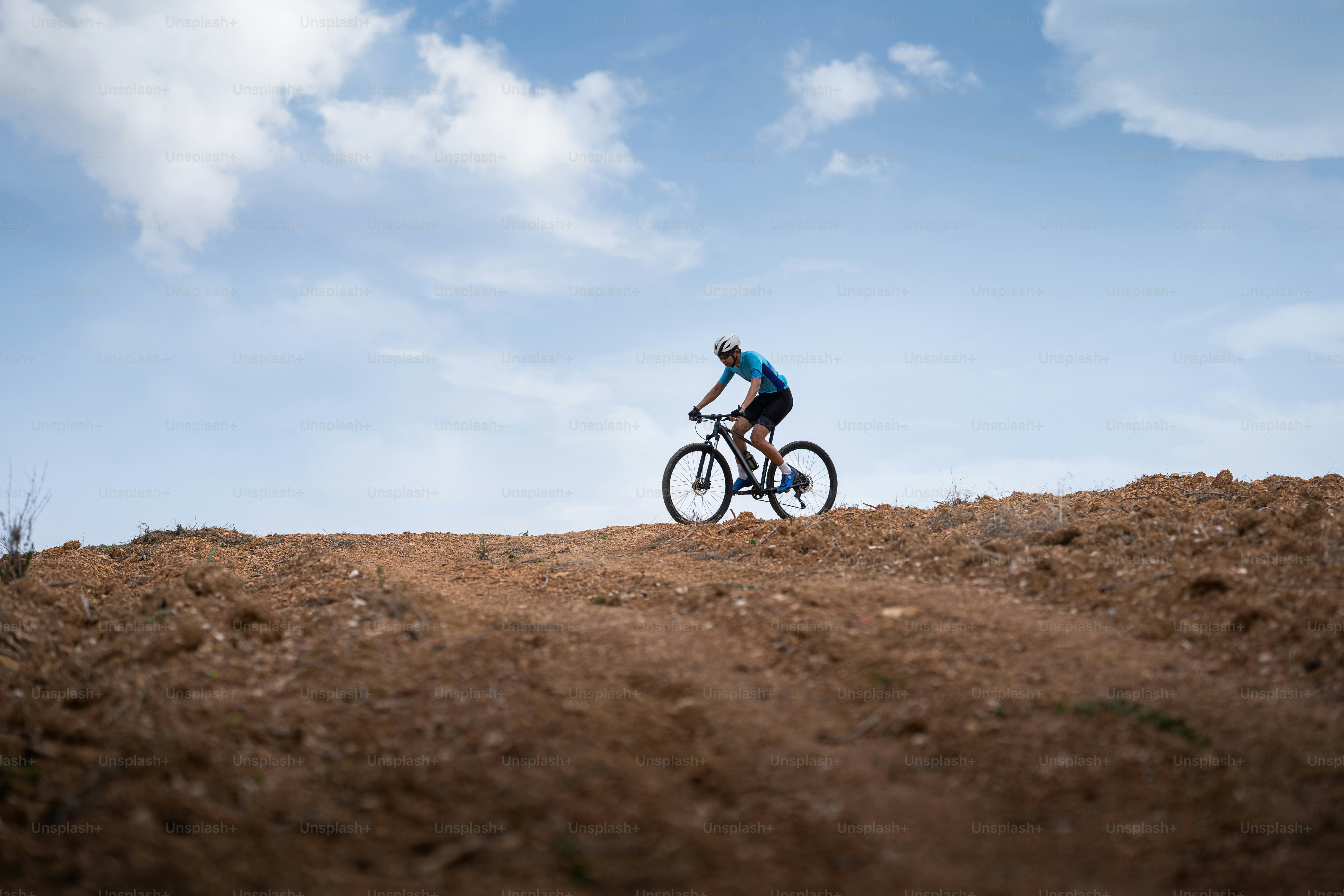 Mountain biker cycling, training and going up a steep climb. photo ...